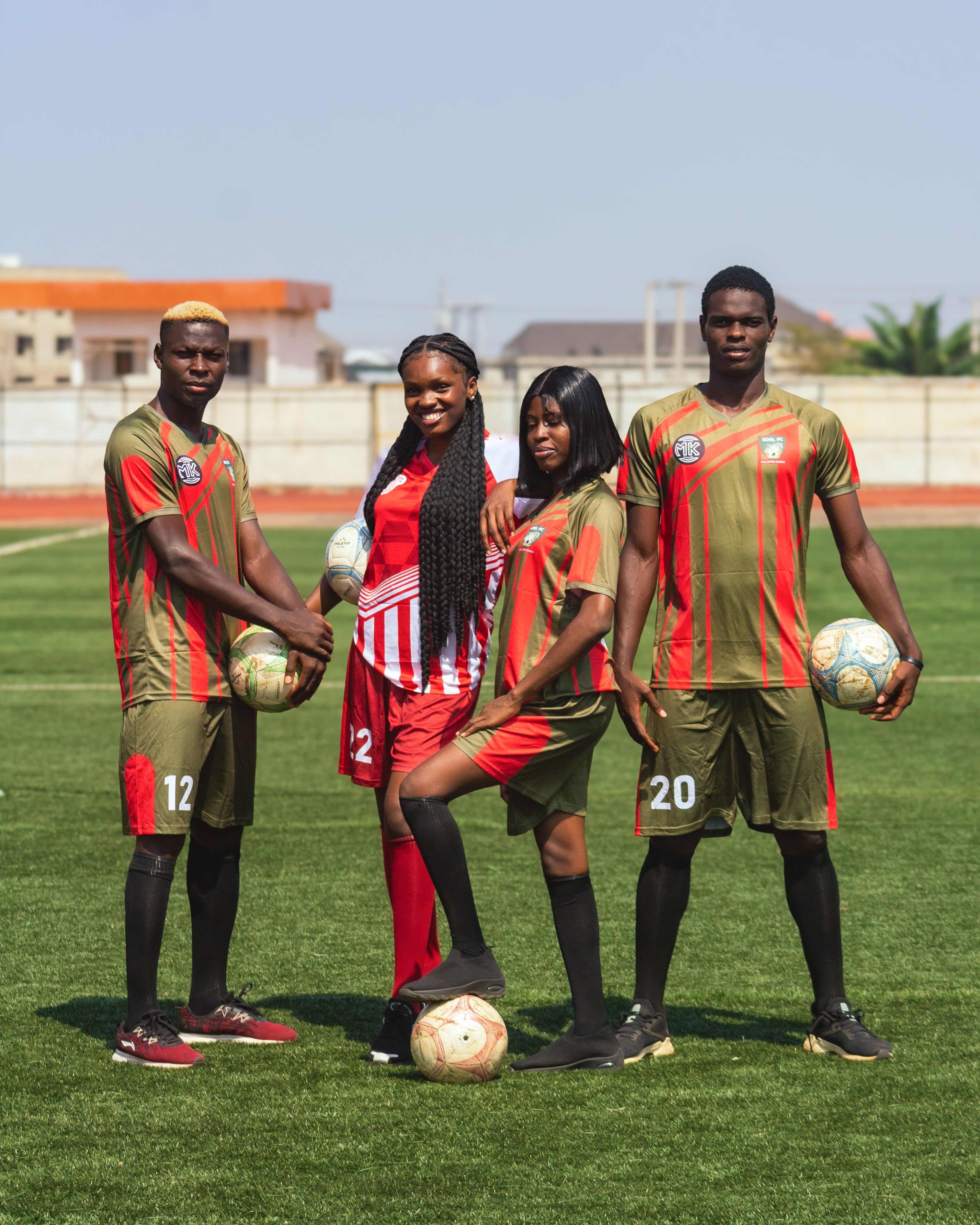 Diverse Soccer Team Posing on Football Field · Free Stock Photo