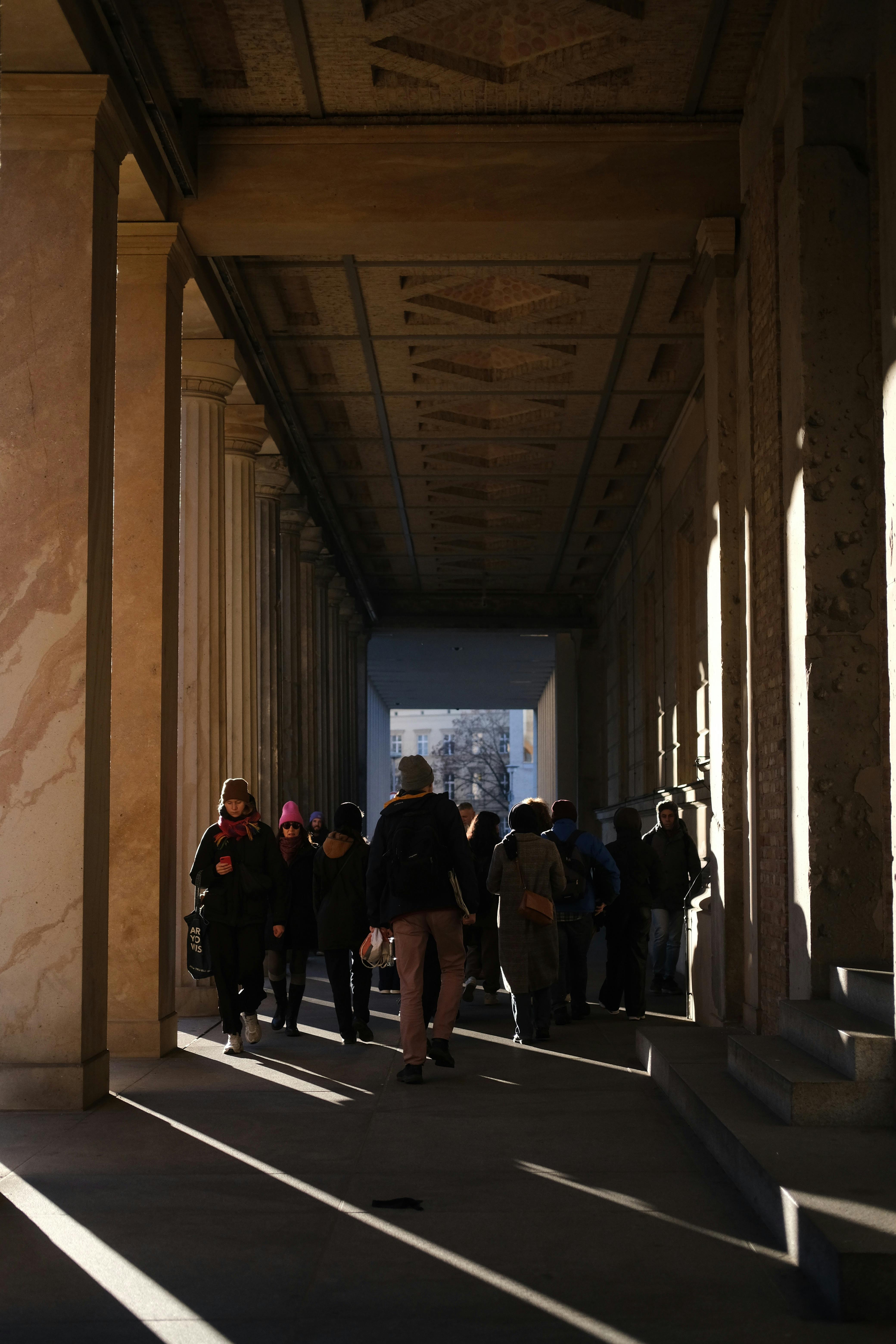 Shadowy Urban Corridor with Walking People · Free Stock Photo