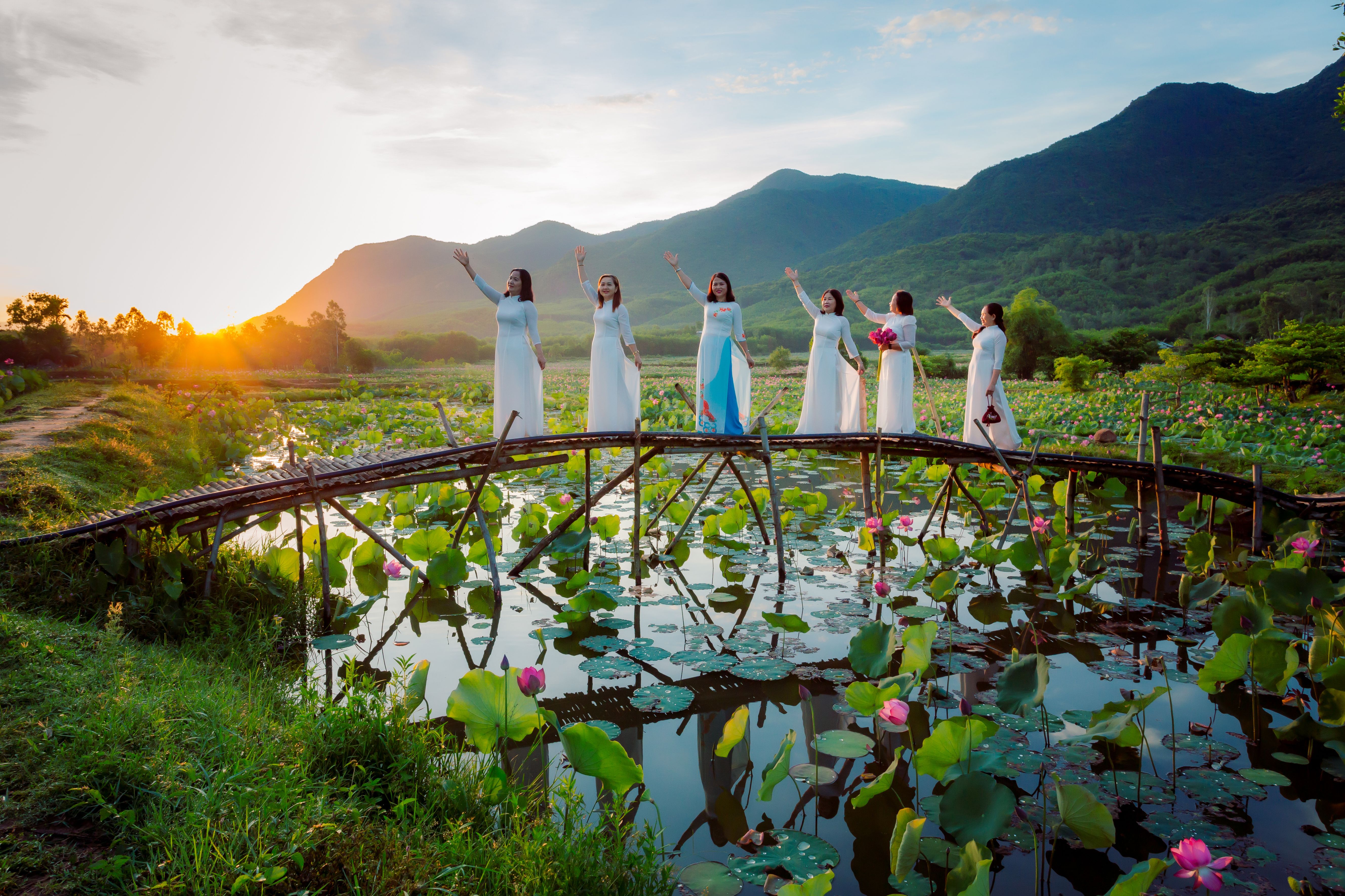 Women in Traditional Dress on Lotus Pond Bridge · Free Stock Photo