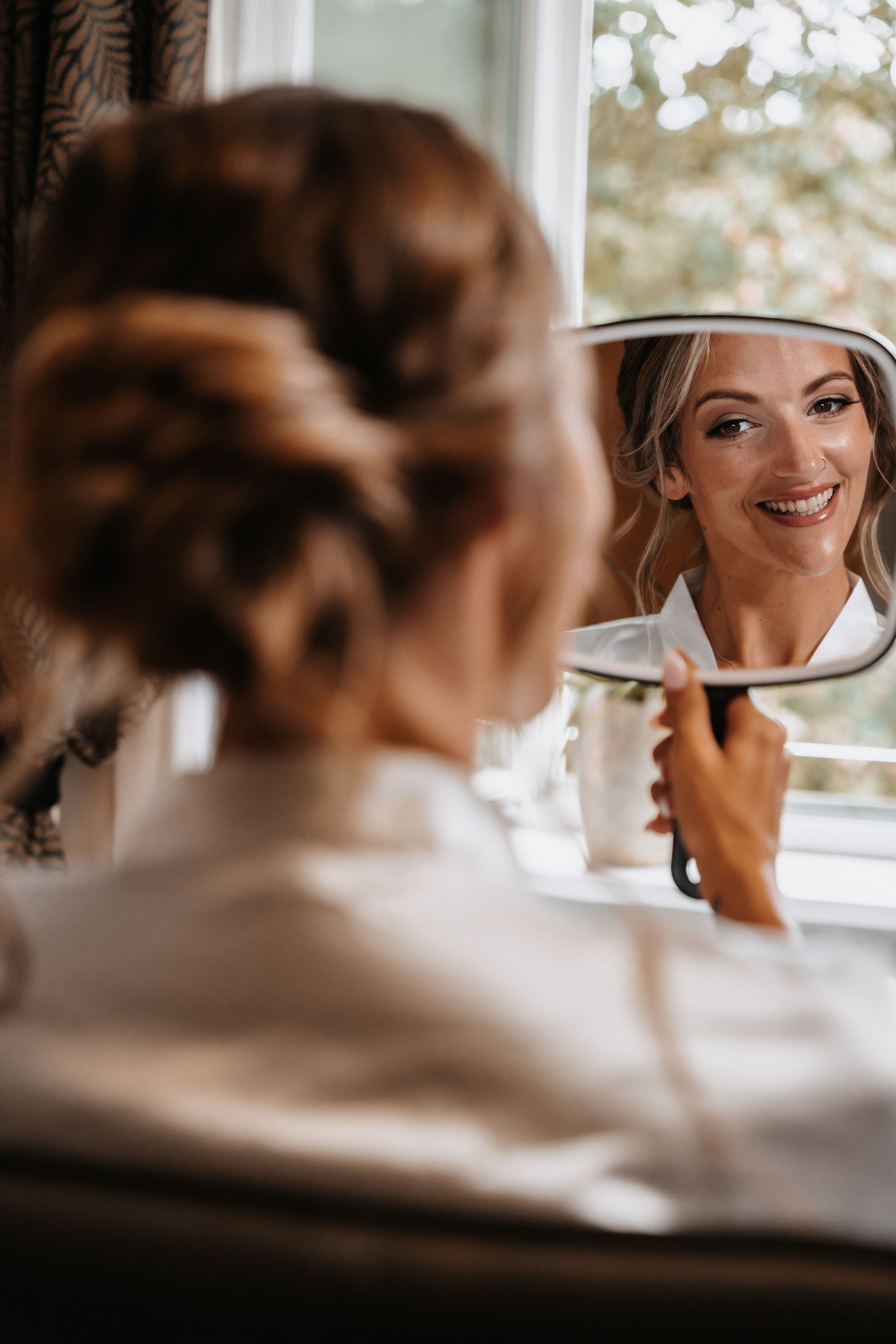 Bride Smiling in Mirror Before Wedding Ceremony · Free Stock Photo