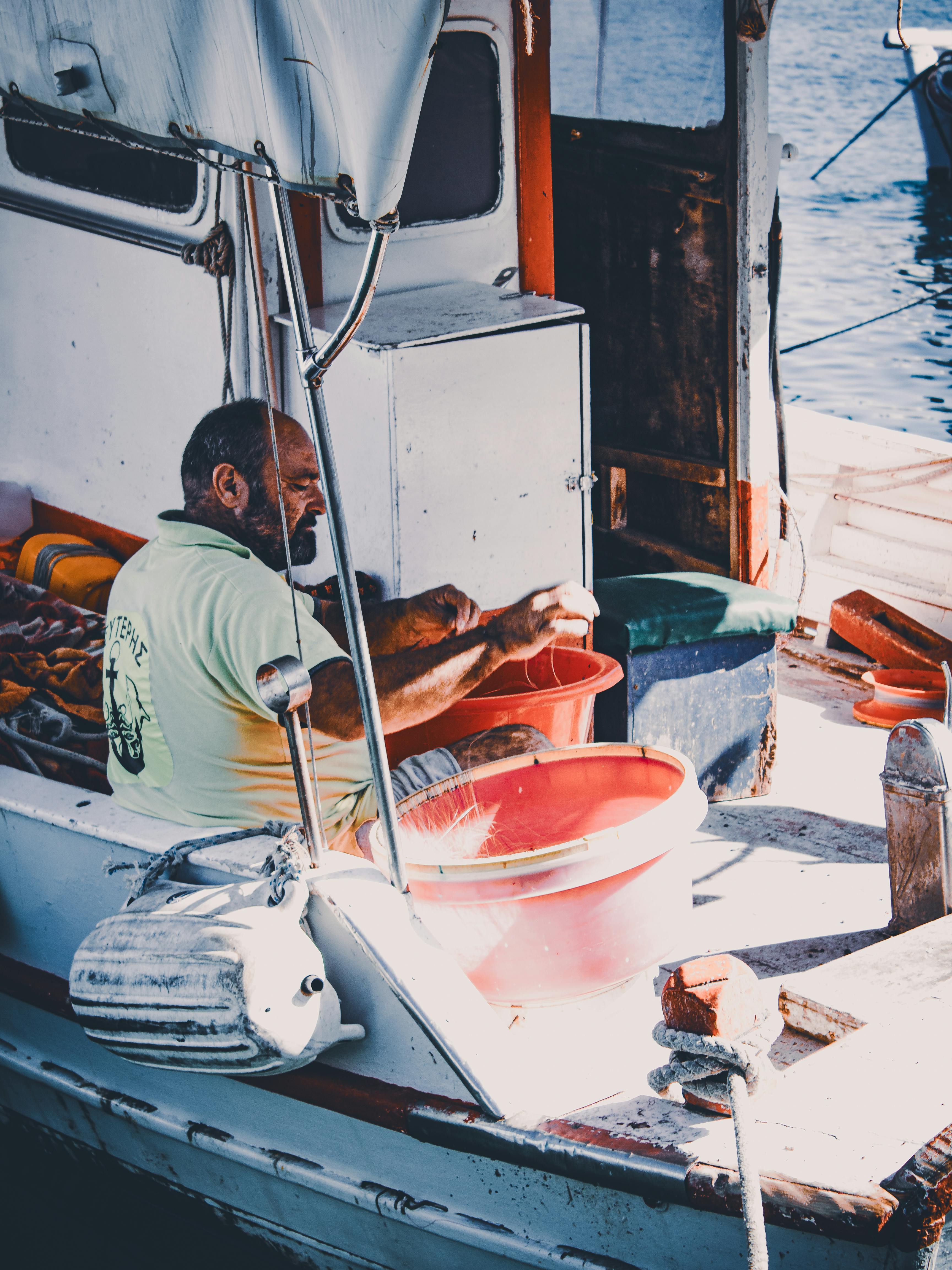 Fisherman Working on Boat in Greece · Free Stock Photo
