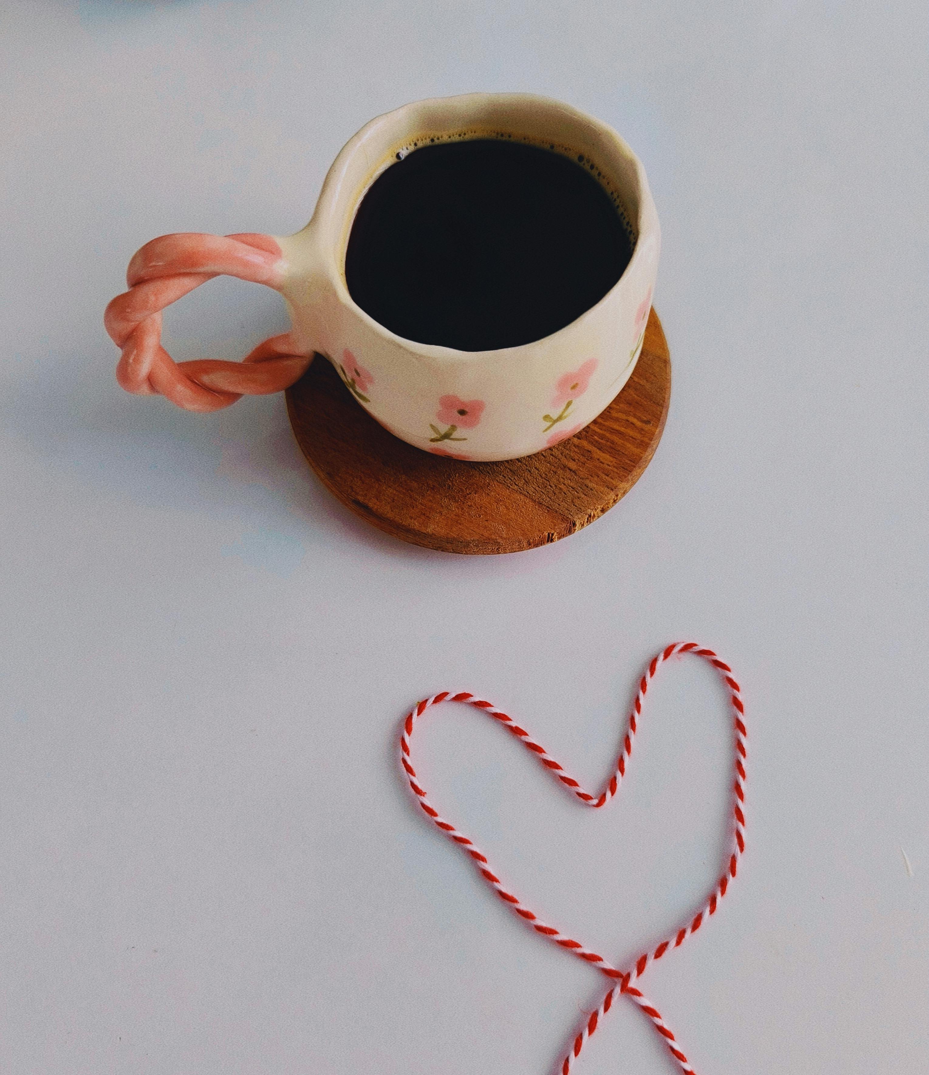 Charming Coffee Cup with Heart String on Table · Free Stock Photo