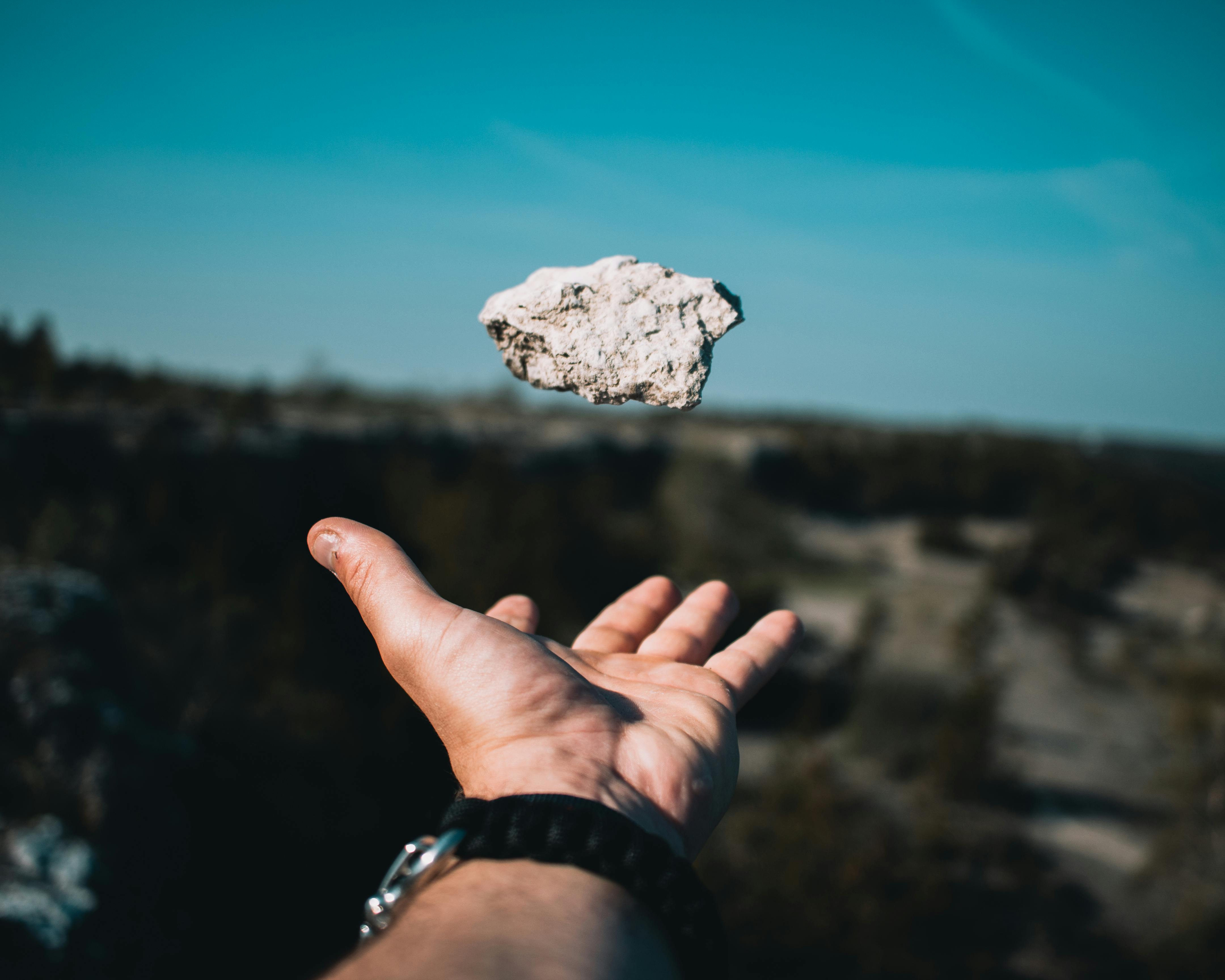 A Person Tossing a Rock · Free Stock Photo