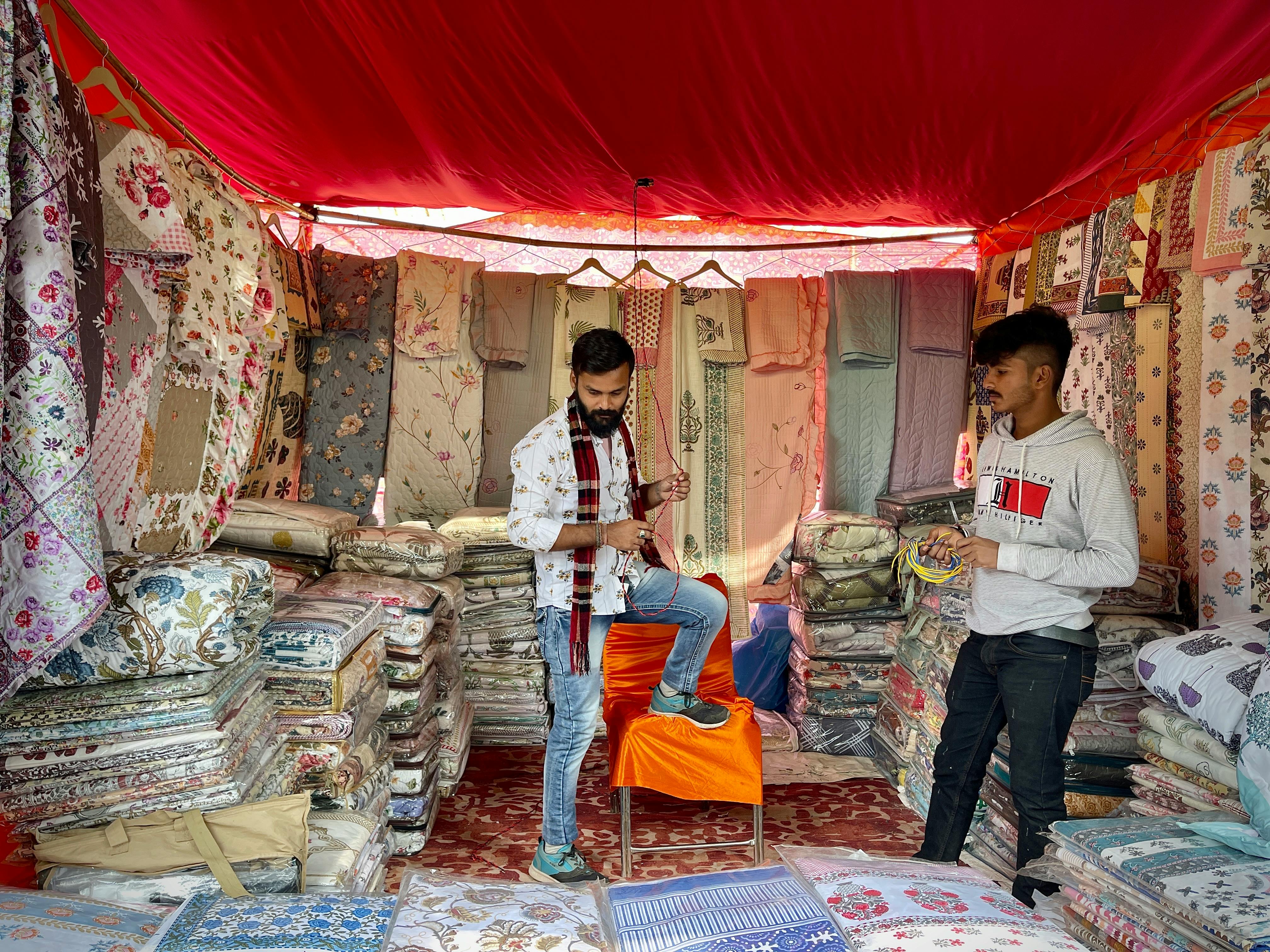 Textile Market Stall with Colorful Fabrics Display · Free Stock Photo