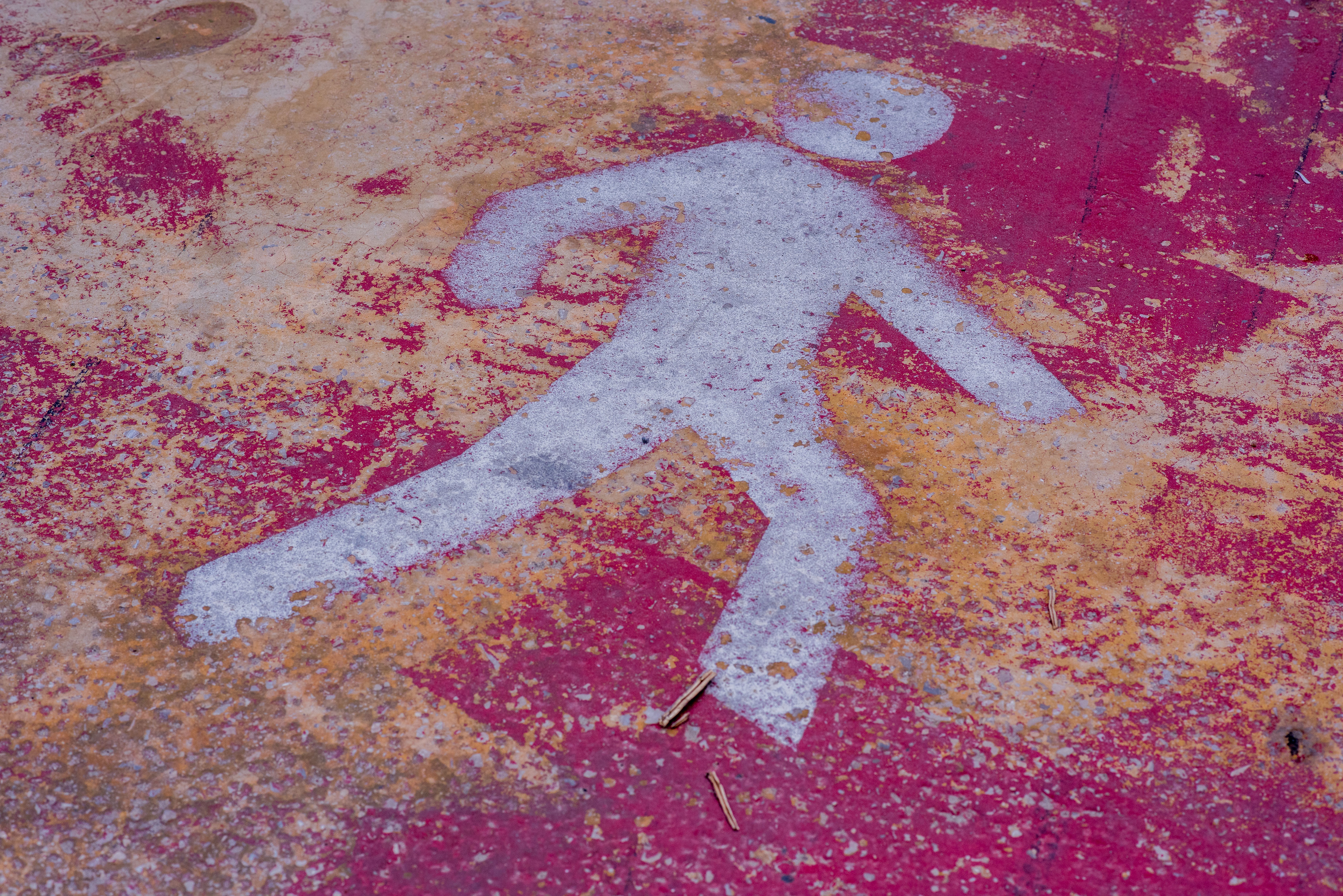 Pedestrian Symbol on Weathered Urban Pavement · Free Stock Photo