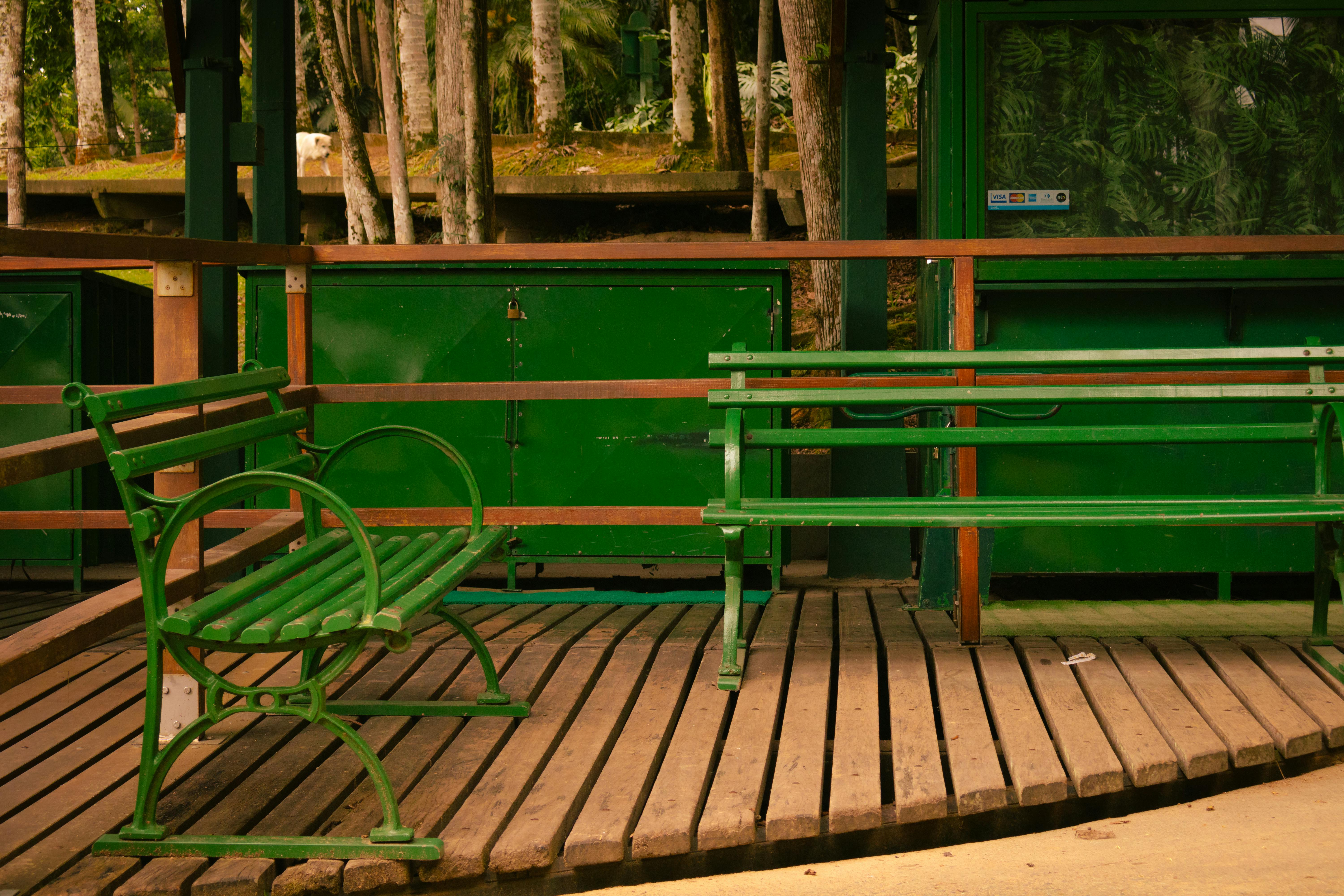 Serene Outdoor Wooden Bench Seating Area · Free Stock Photo