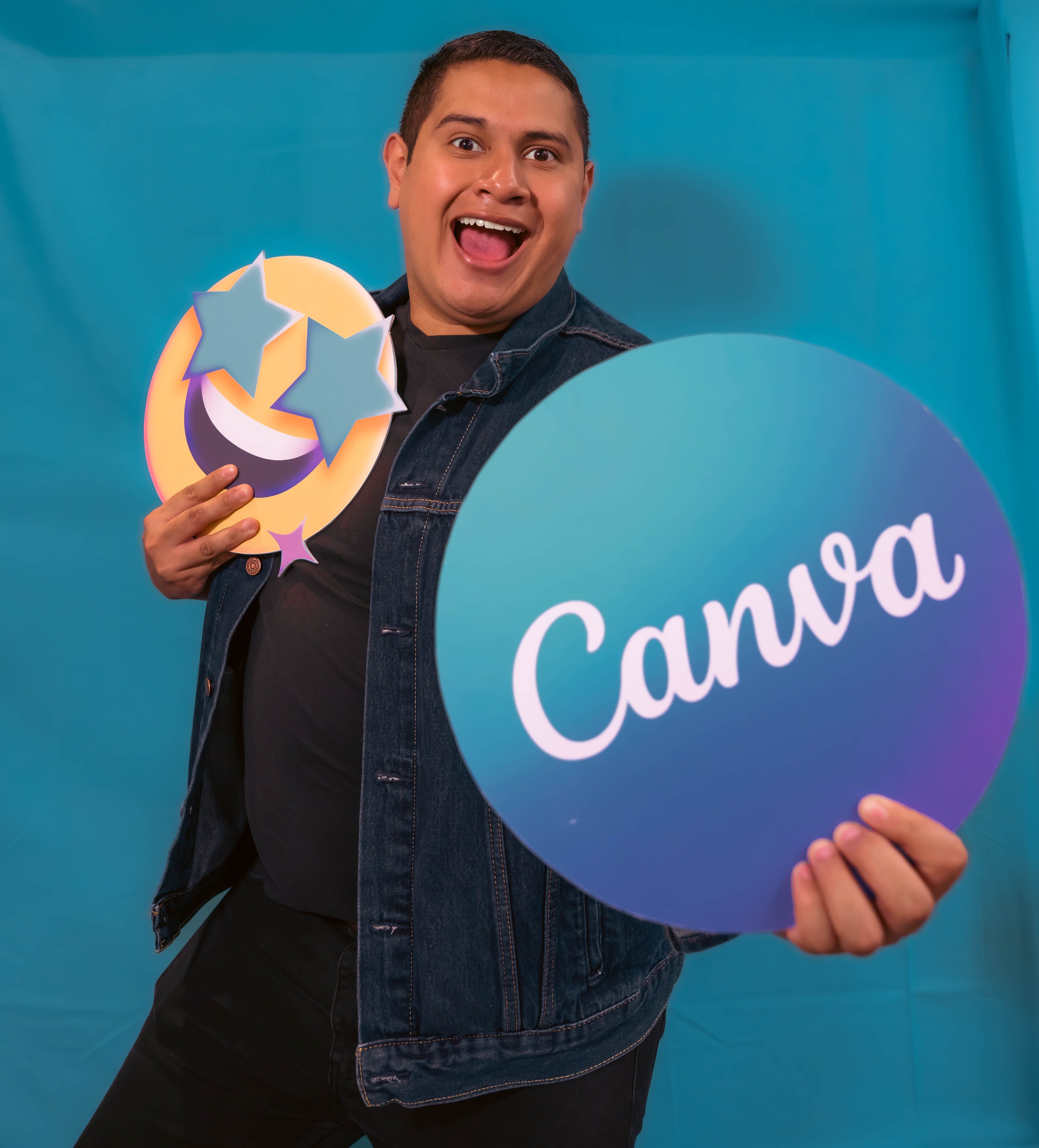 Cheerful Person Holding Canva Sign Against Blue Background · Free Stock ...