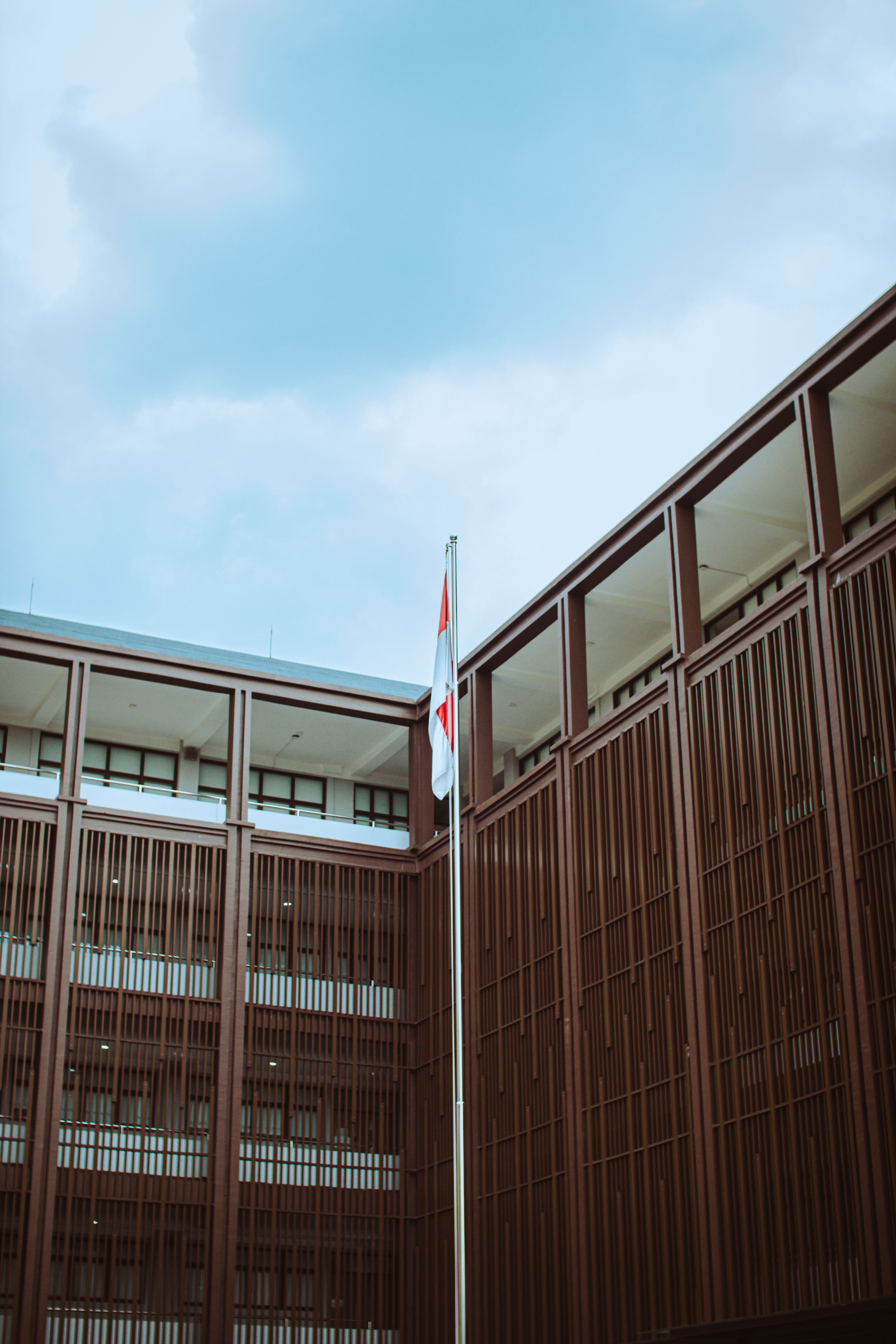 Modern Building with Indonesian Flag Display · Free Stock Photo