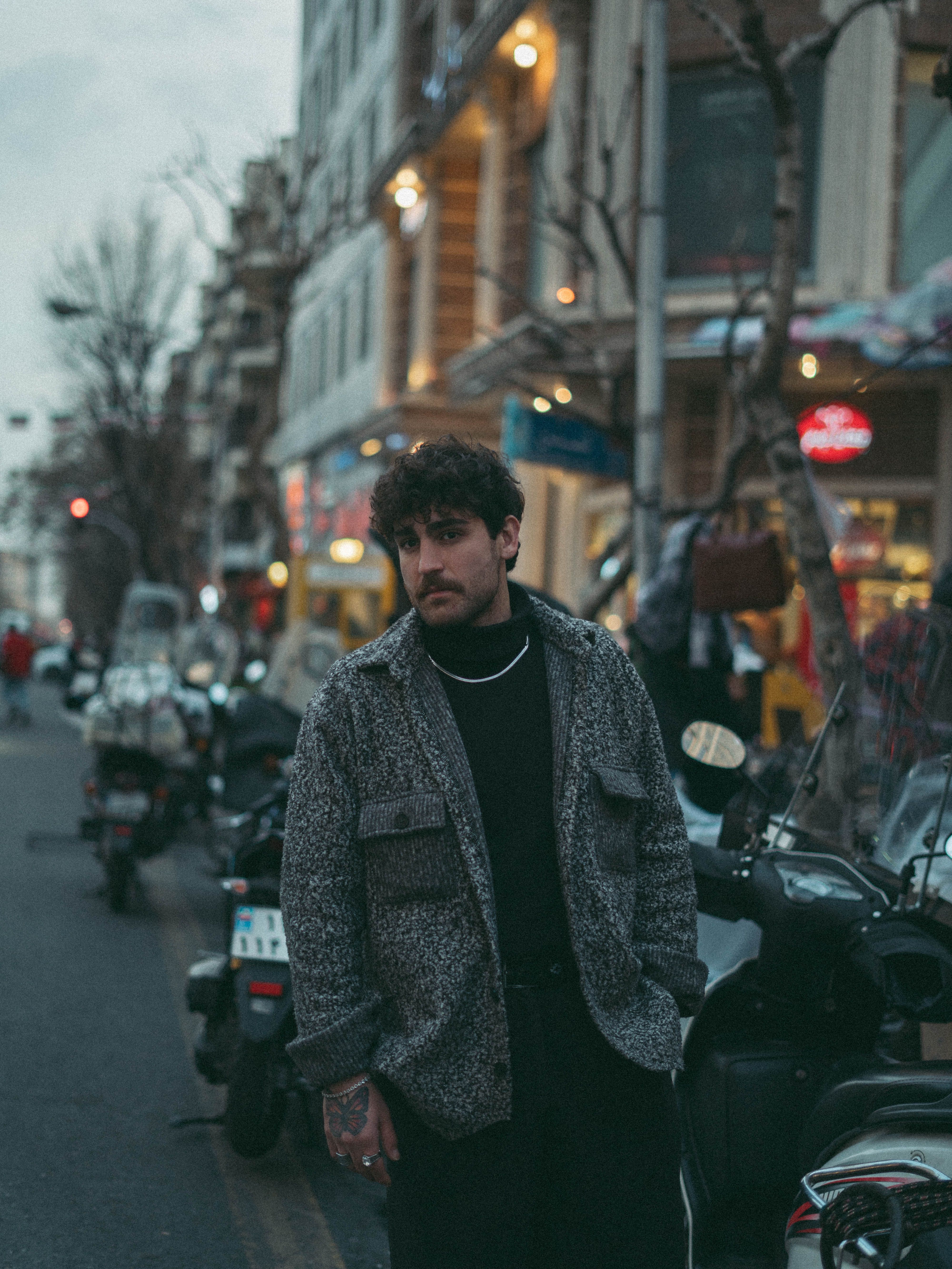 Man in Urban Streetwear on City Sidewalk · Free Stock Photo