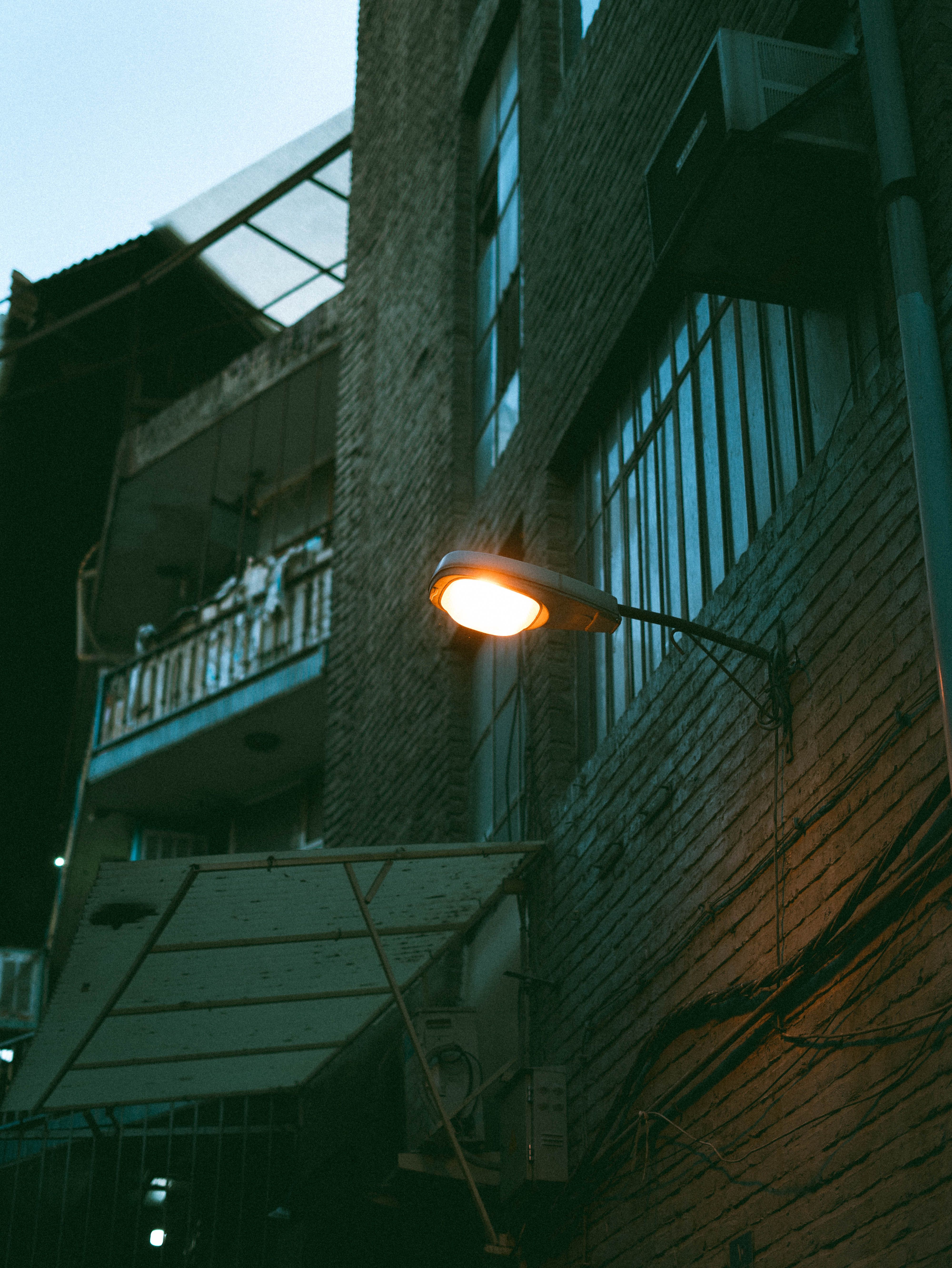 Moody Urban Alley with Illuminated Streetlight · Free Stock Photo