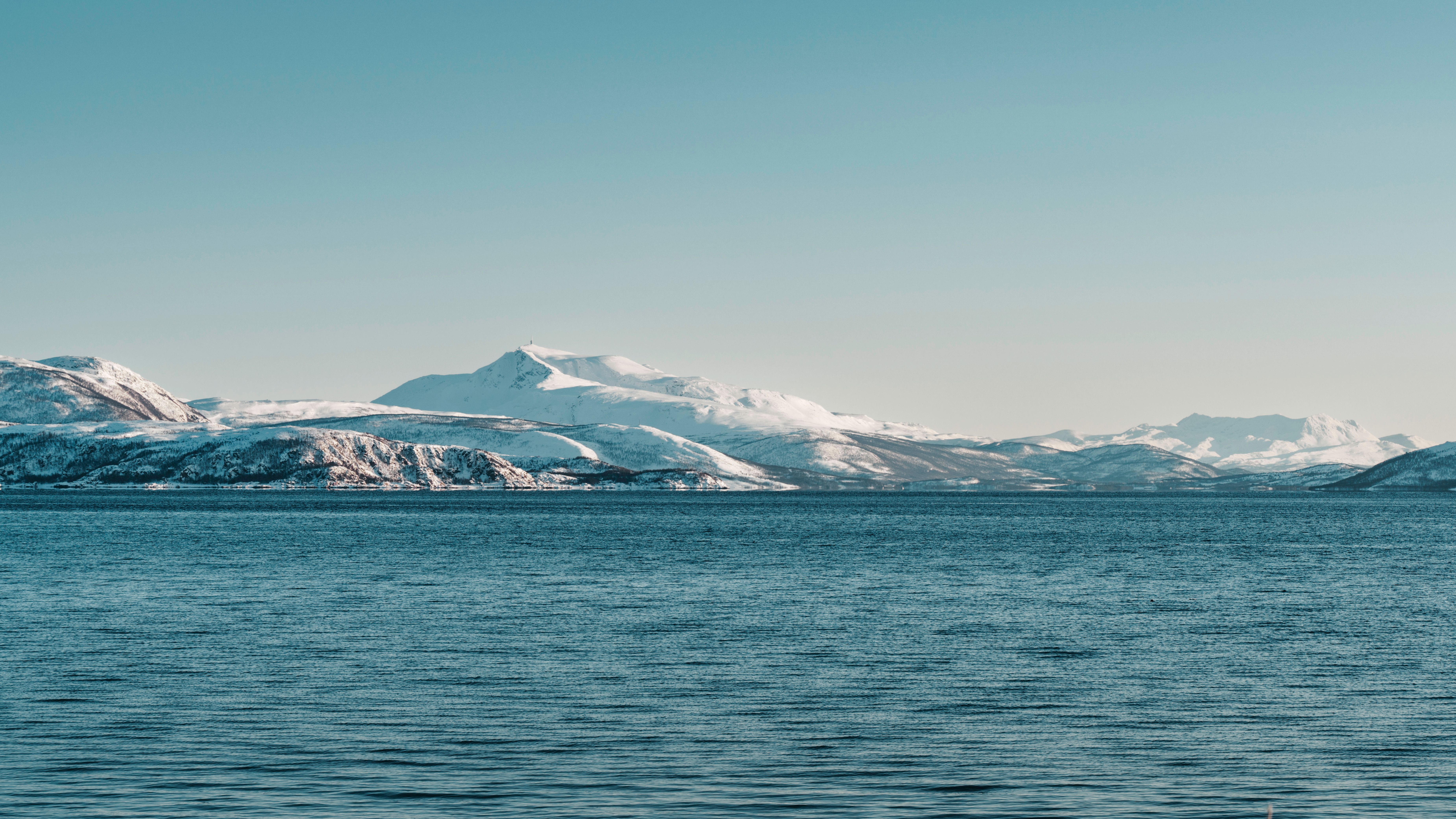 Snowy Norwegian Mountains and Ocean View · Free Stock Photo