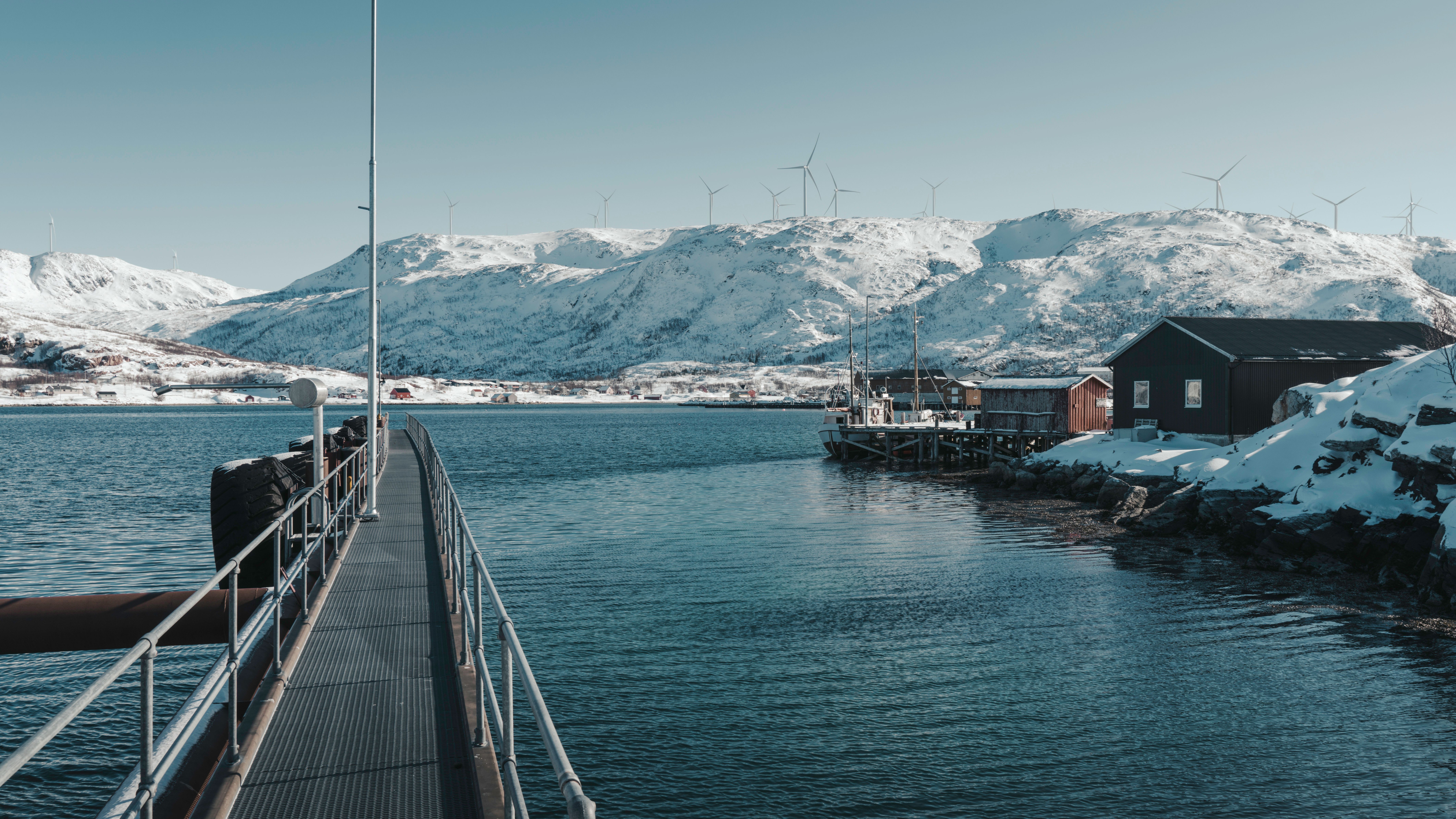 Snowy Norwegian Fjord with Wind Turbines · Free Stock Photo