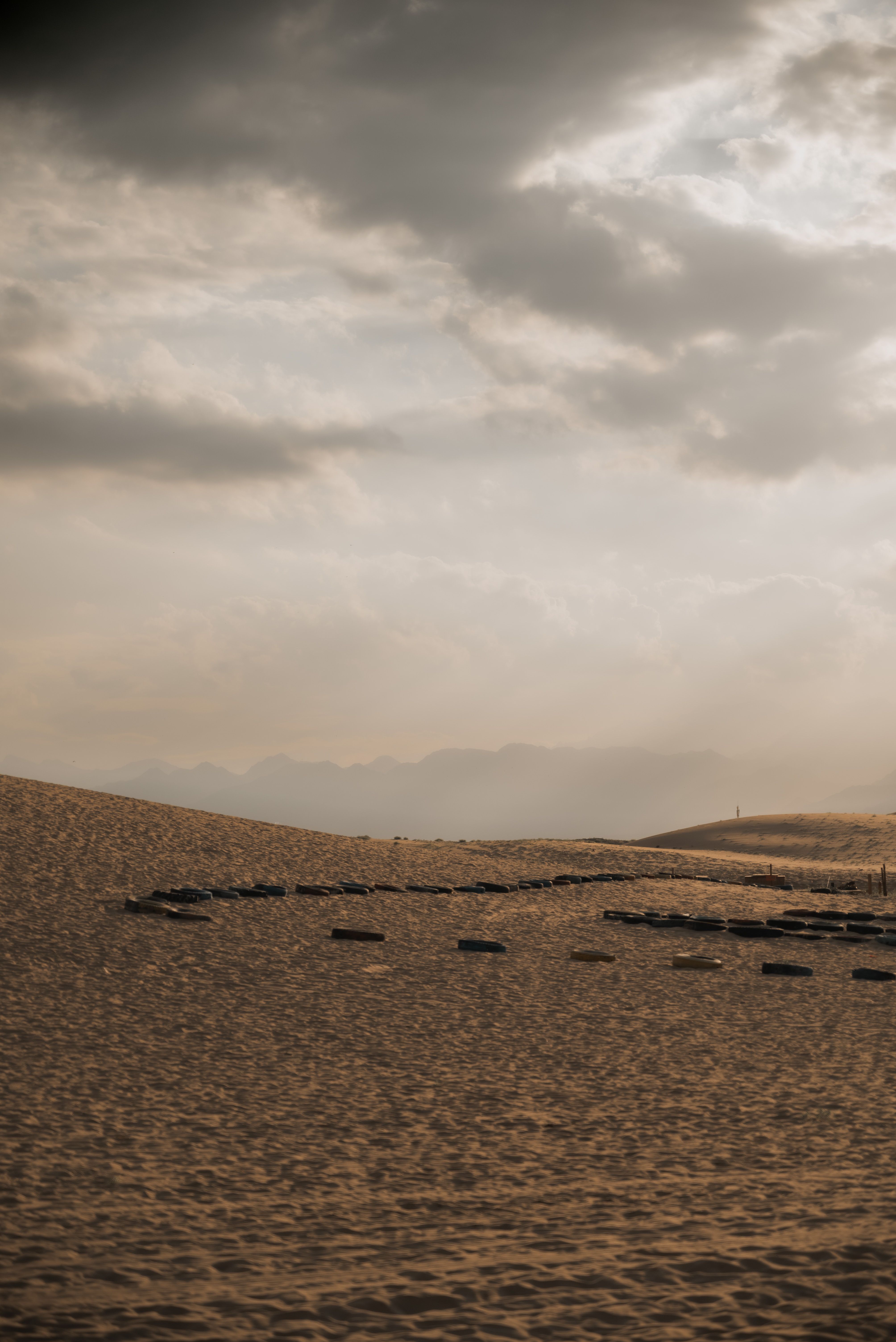 Dramatic Desert Landscape under Cloudy Skies · Free Stock Photo