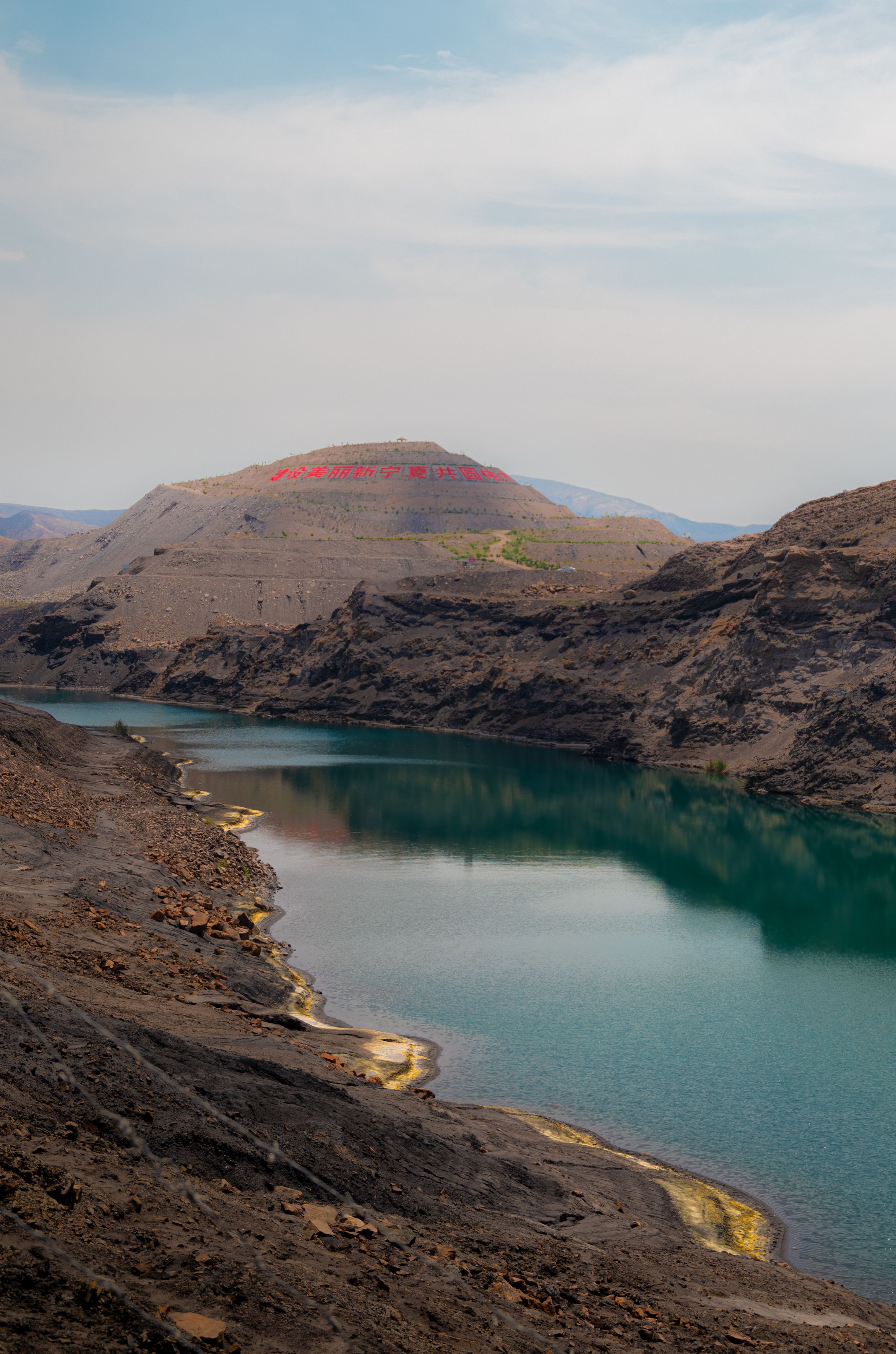 Scenic Volcanic Lake Surrounded by Rugged Terrain · Free Stock Photo