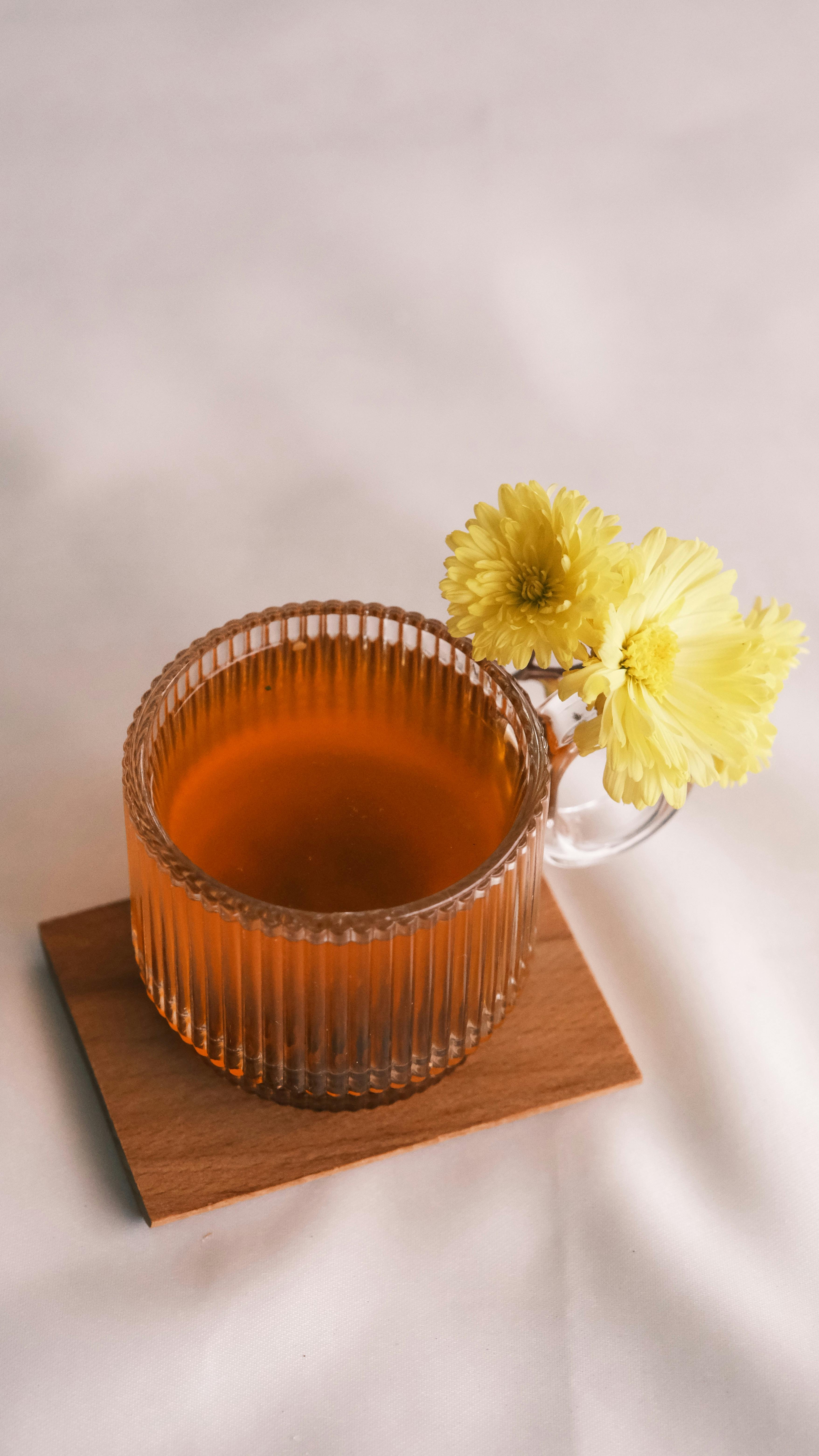 Elegant Glass Mug of Herbal Tea with Flowers · Free Stock Photo