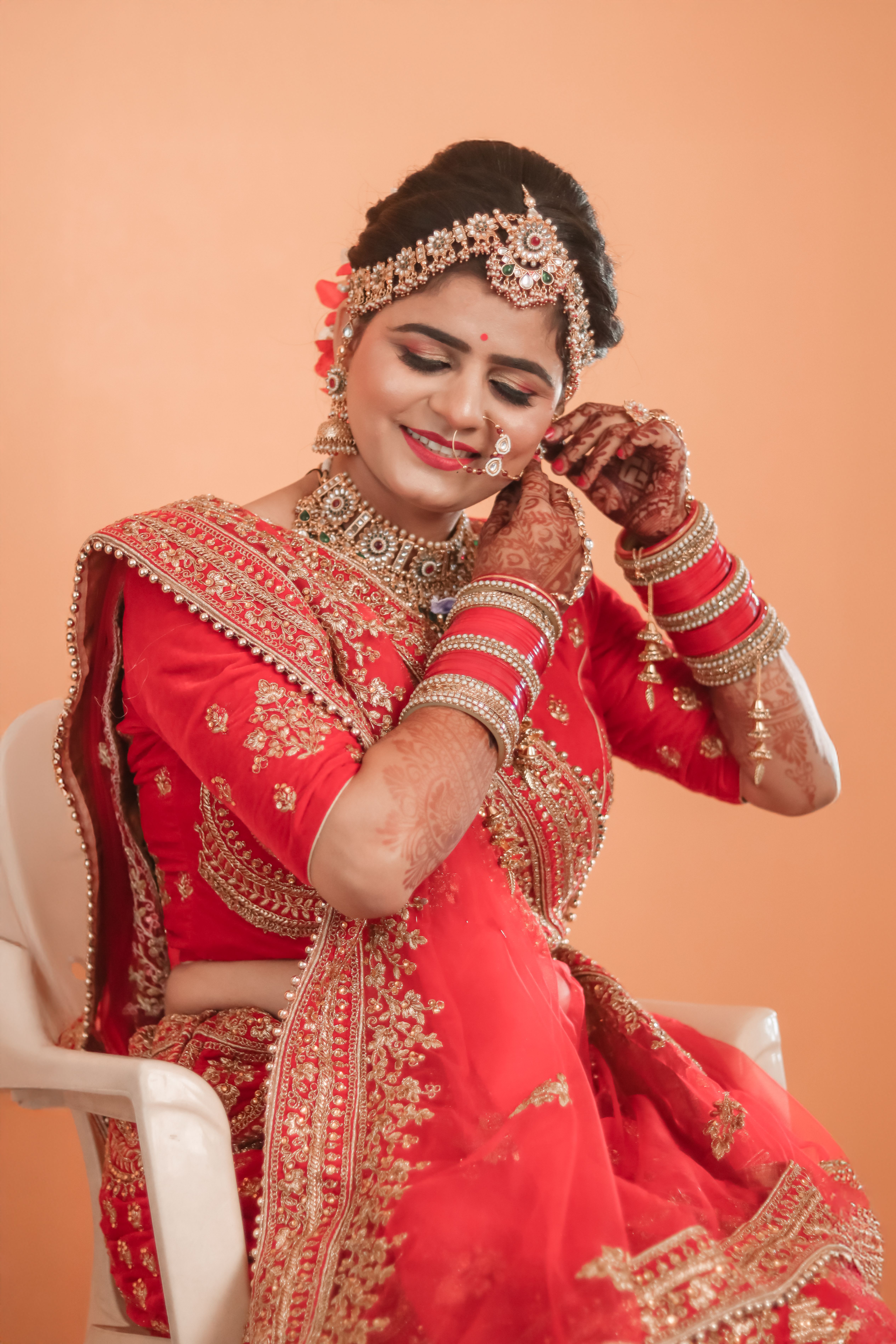 Traditional Indian Bride in Ornate Red Attire · Free Stock Photo
