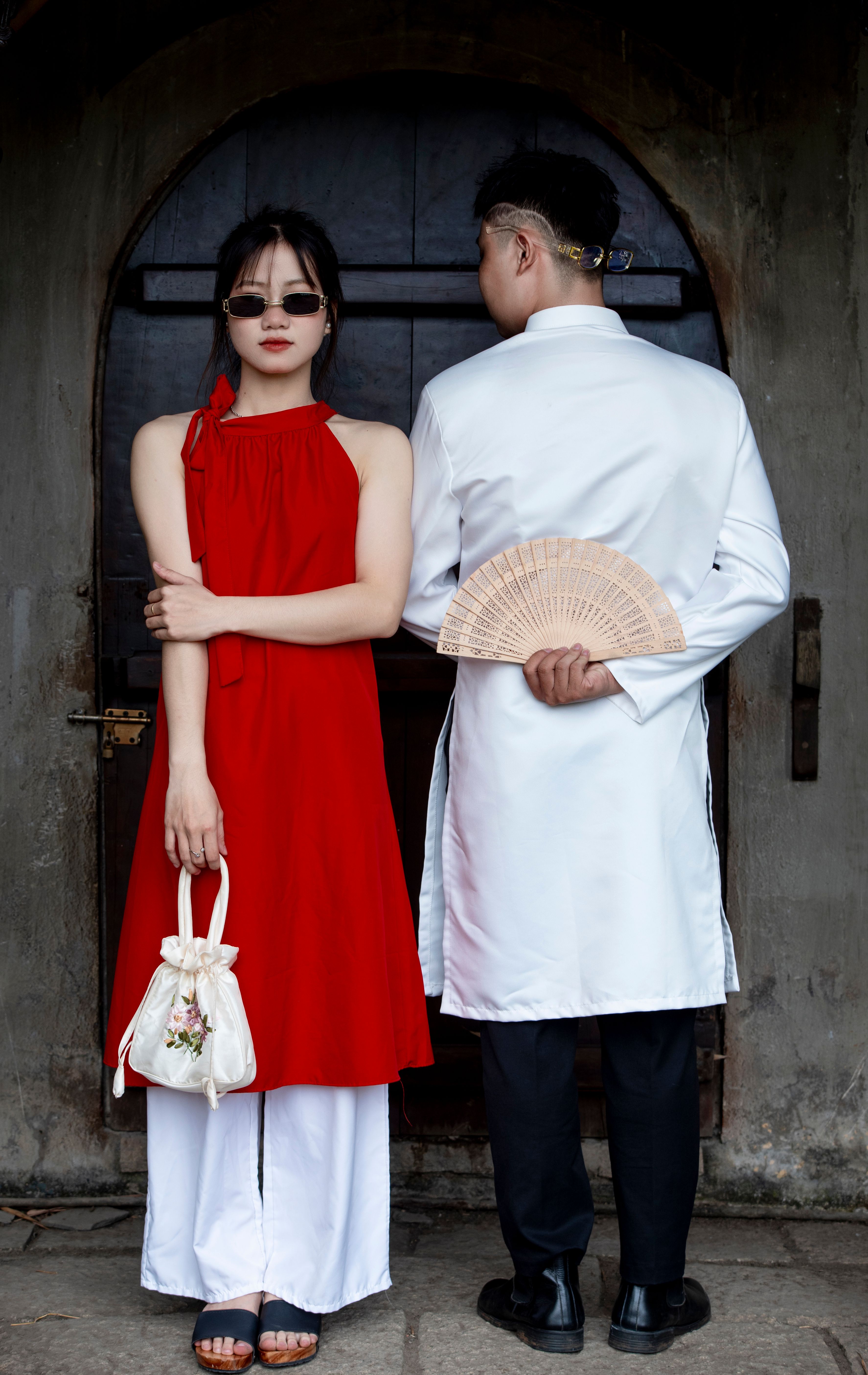 Stylish Couple in Retro Fashion with a Fan · Free Stock Photo