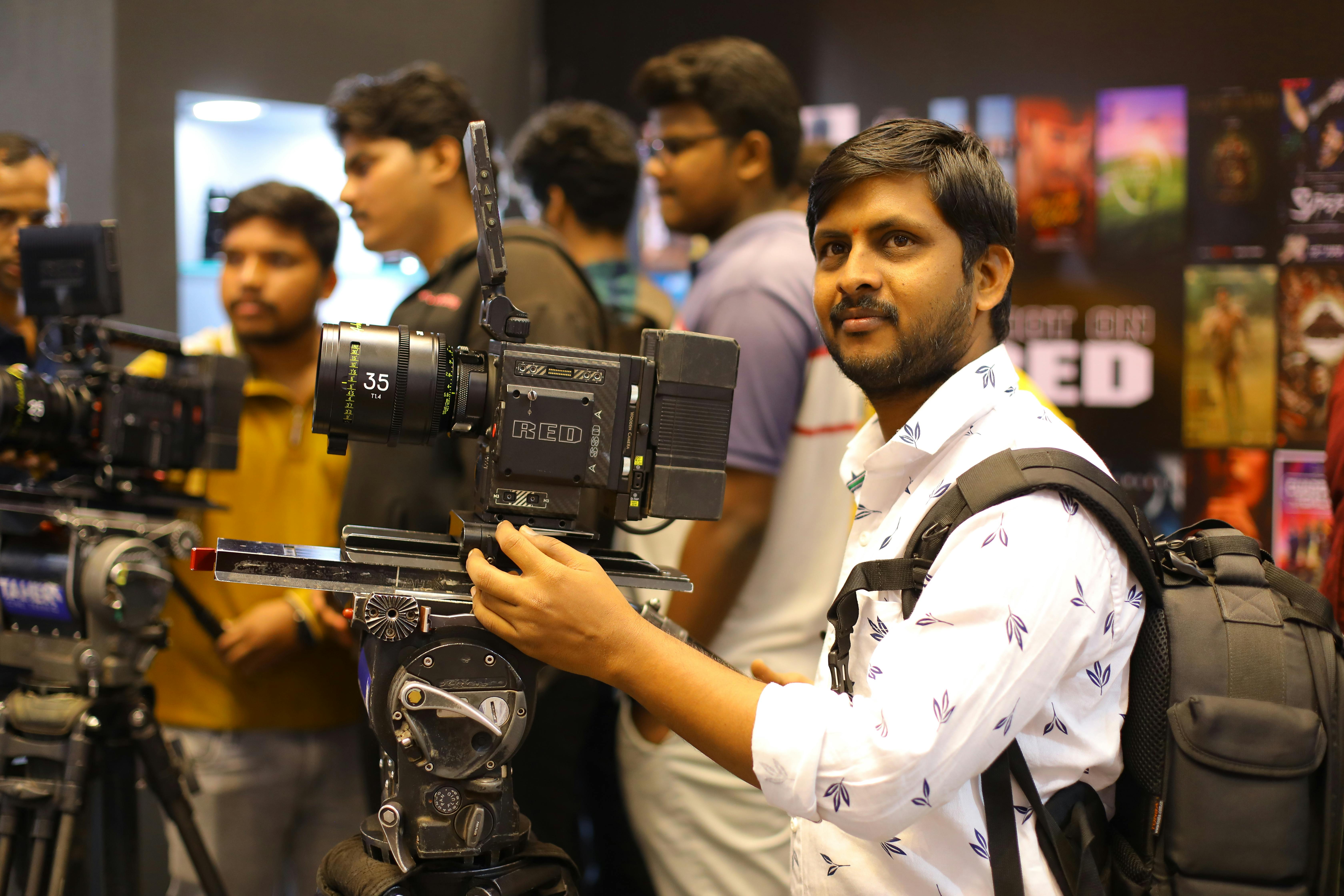 Man Operating Camera at Hyderabad Film Expo · Free Stock Photo