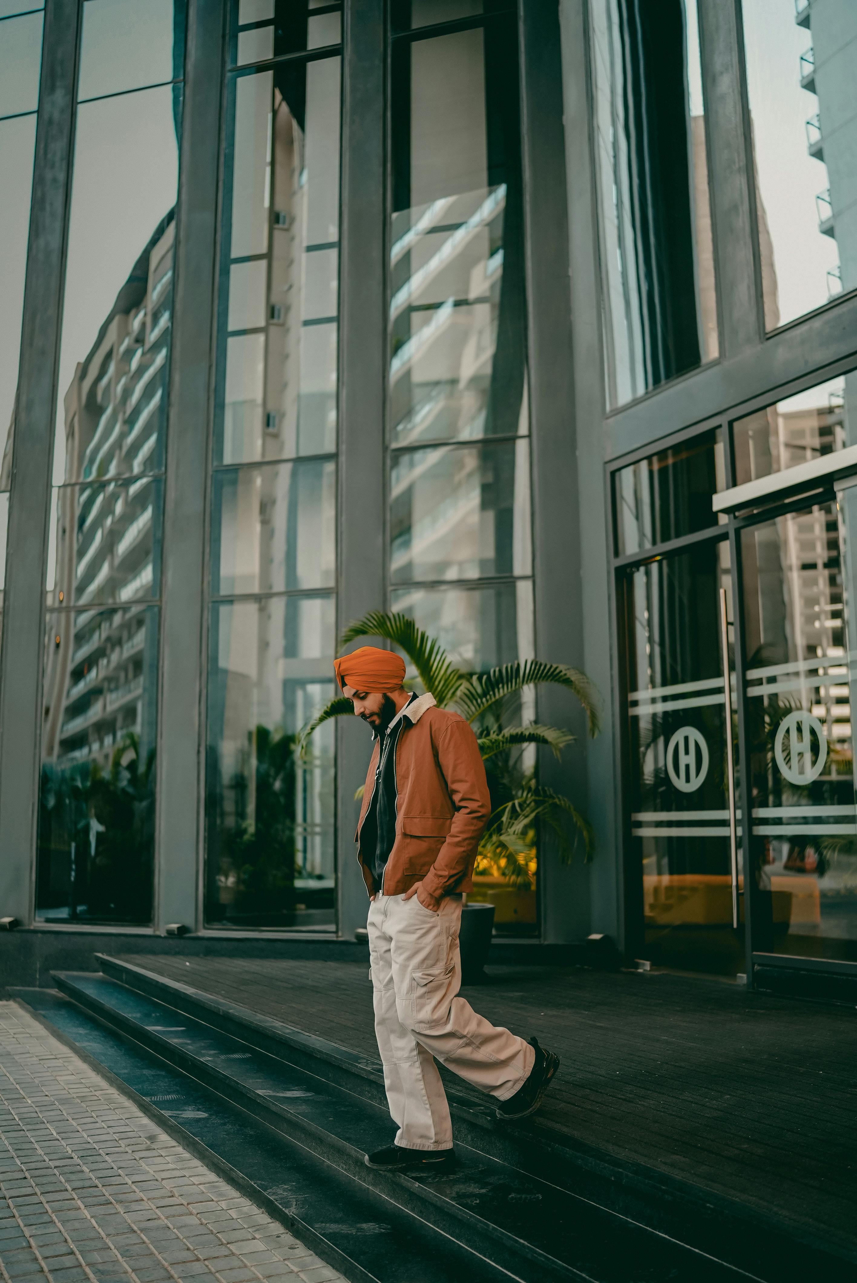 Stylish Man Walking Beside Modern Glass Building · Free Stock Photo