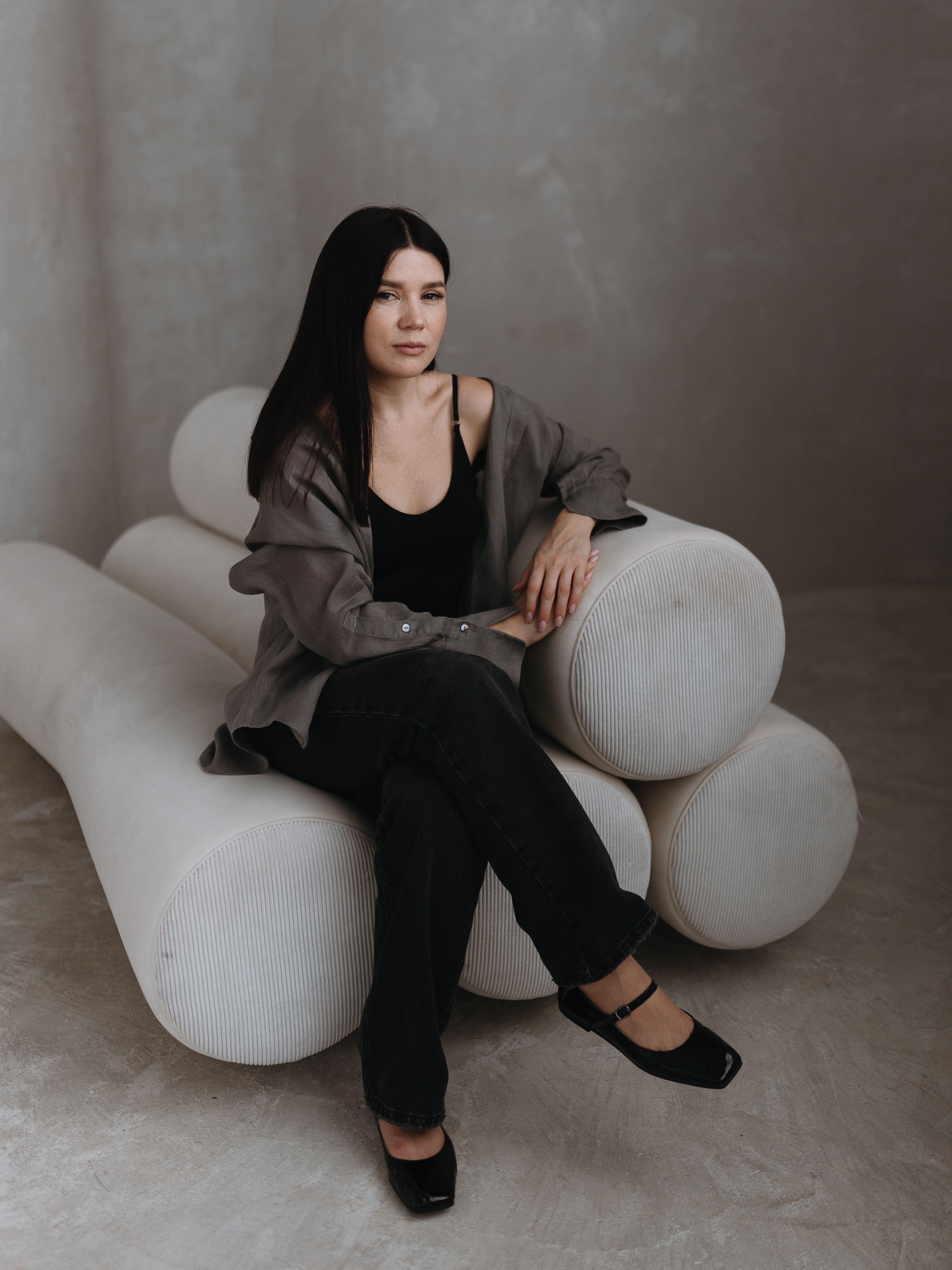 Stylish Woman Sitting on Modern Cylinder Sofa · Free Stock Photo