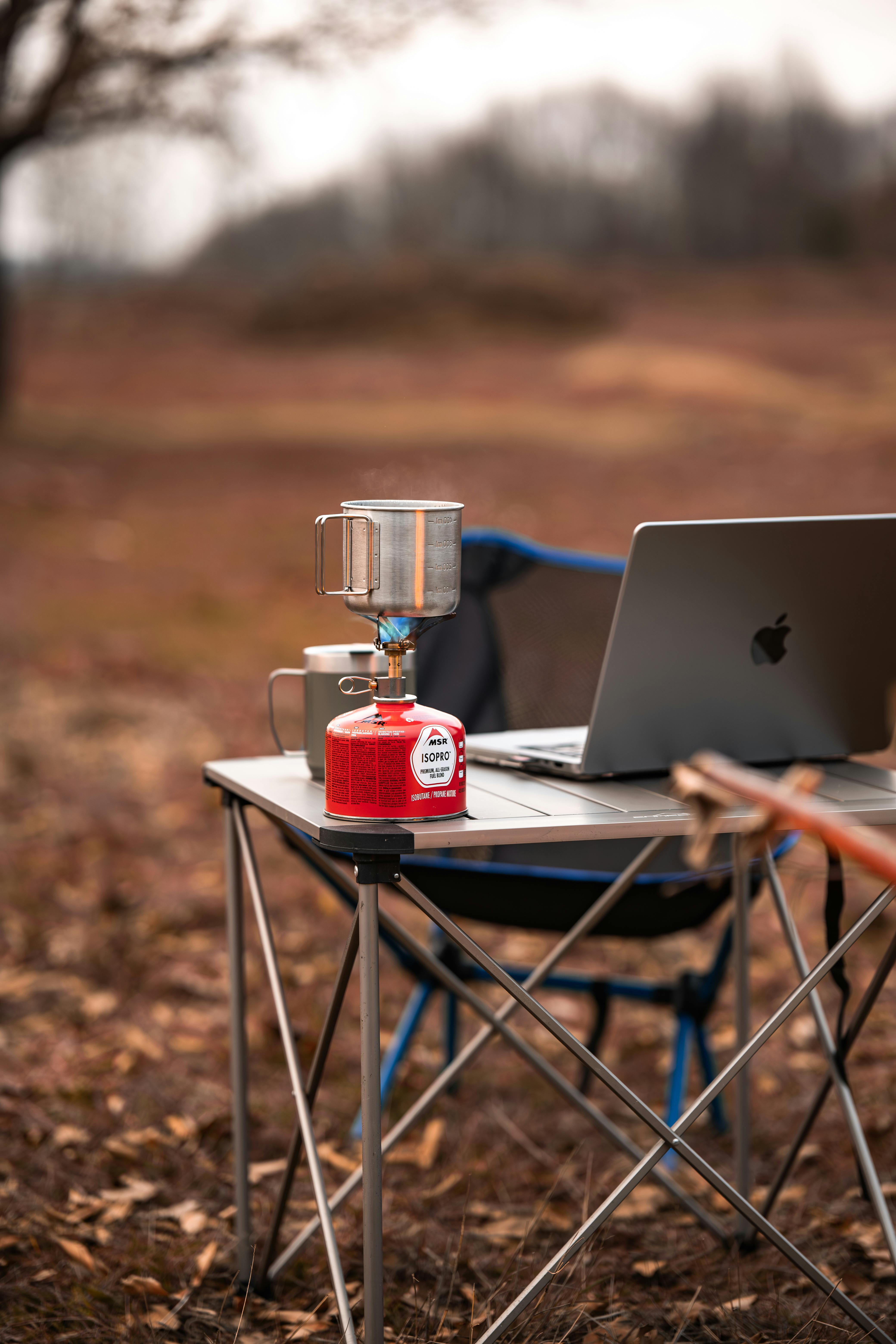 Man working with laptop near tent · Free Stock Photo