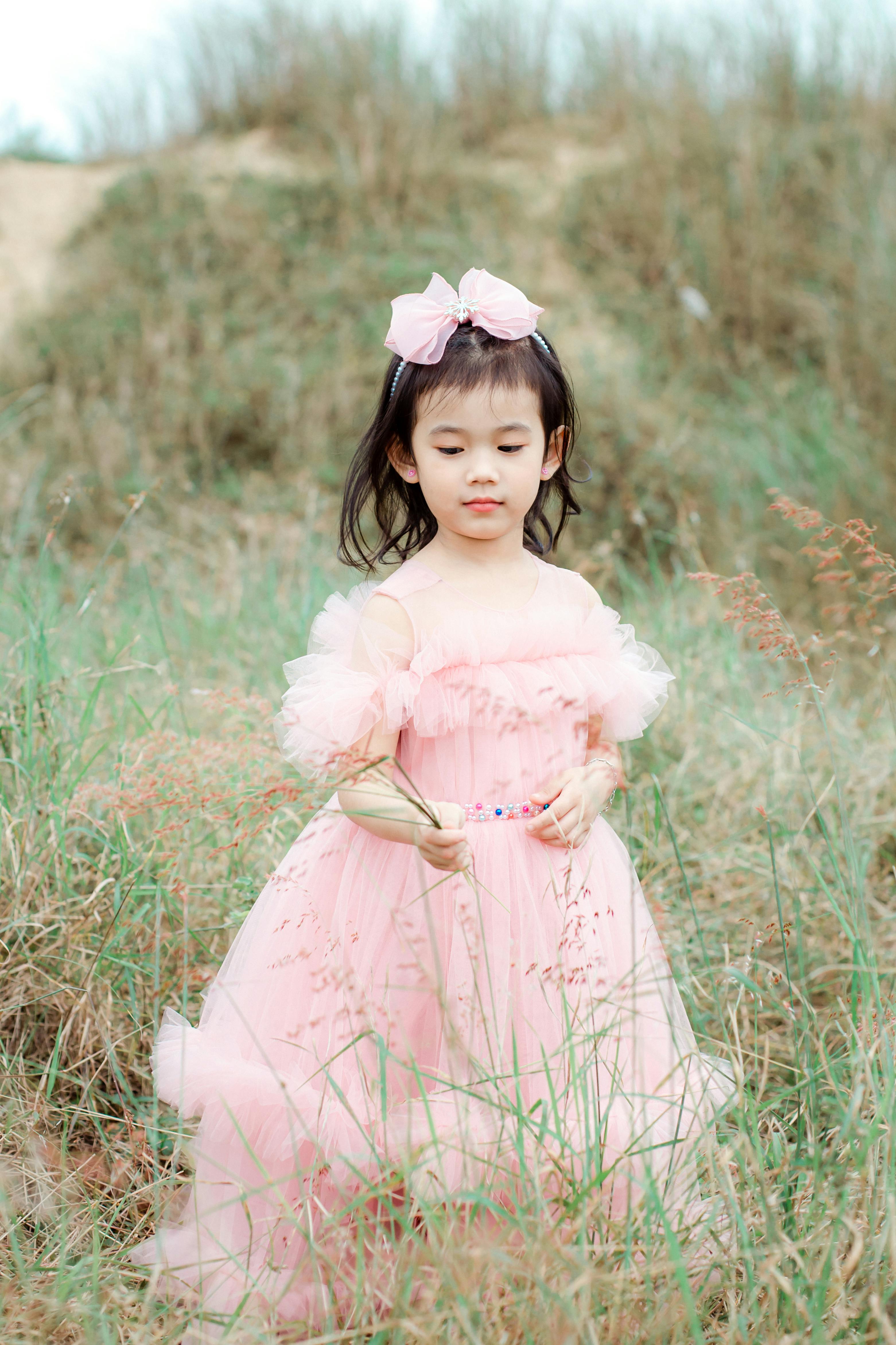Charming Child in Pink Dress Outdoors in Hoi An · Free Stock Photo