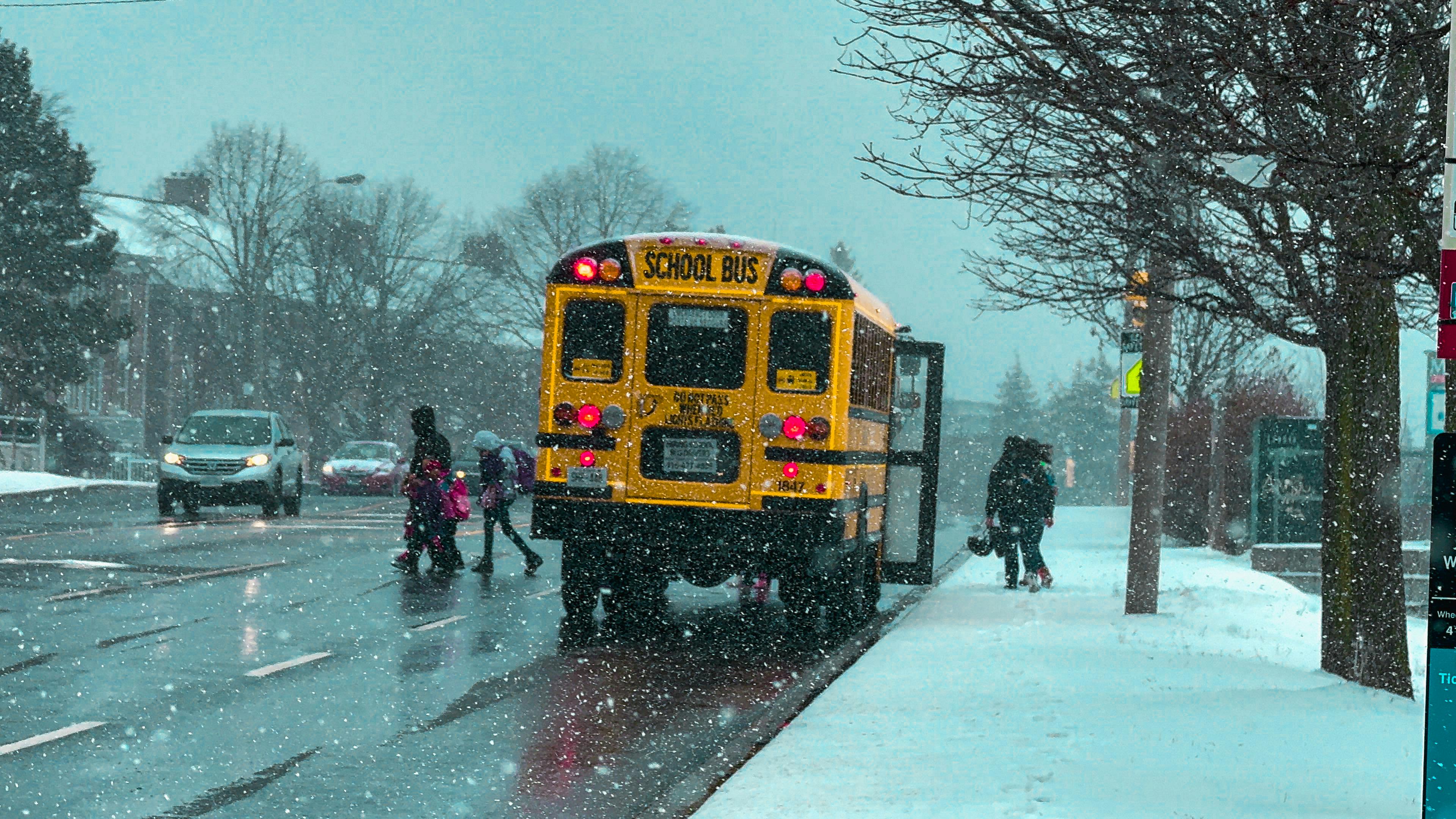 Children Boarding School Bus in Winter Snow · Free Stock Photo