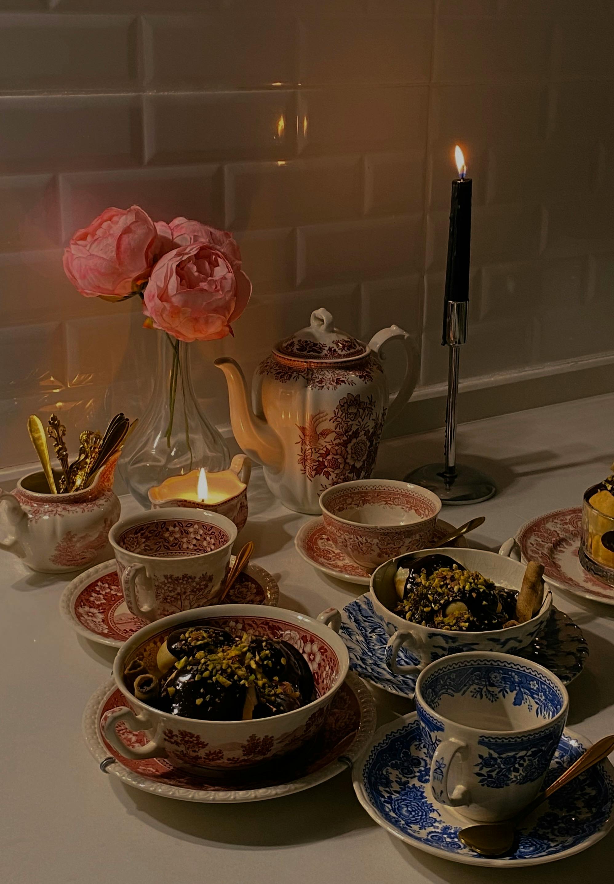 Cozy Evening Tea Set With Desserts and Flowers · Free Stock Photo