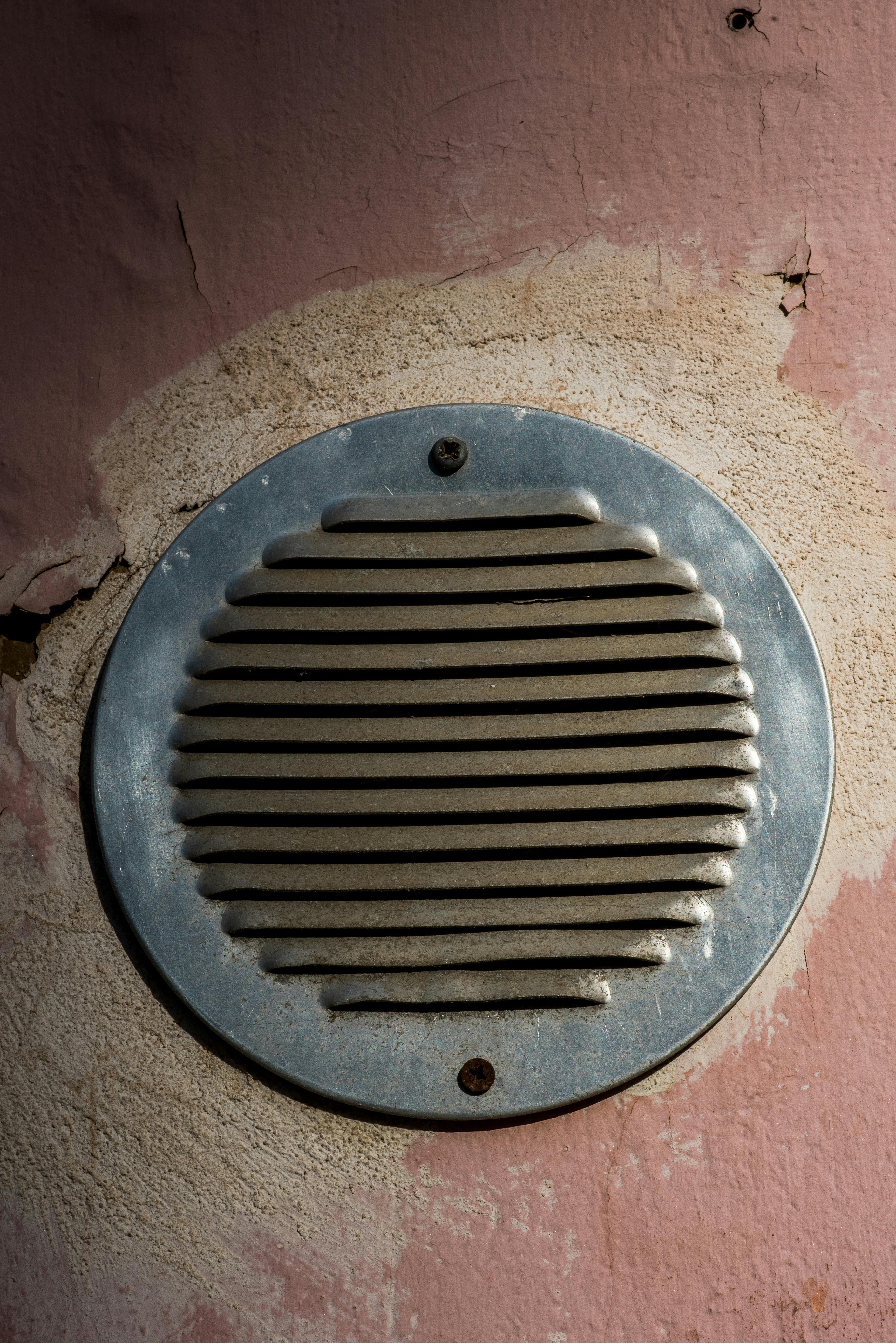 Round Metal Vent on Weathered Wall Surface · Free Stock Photo