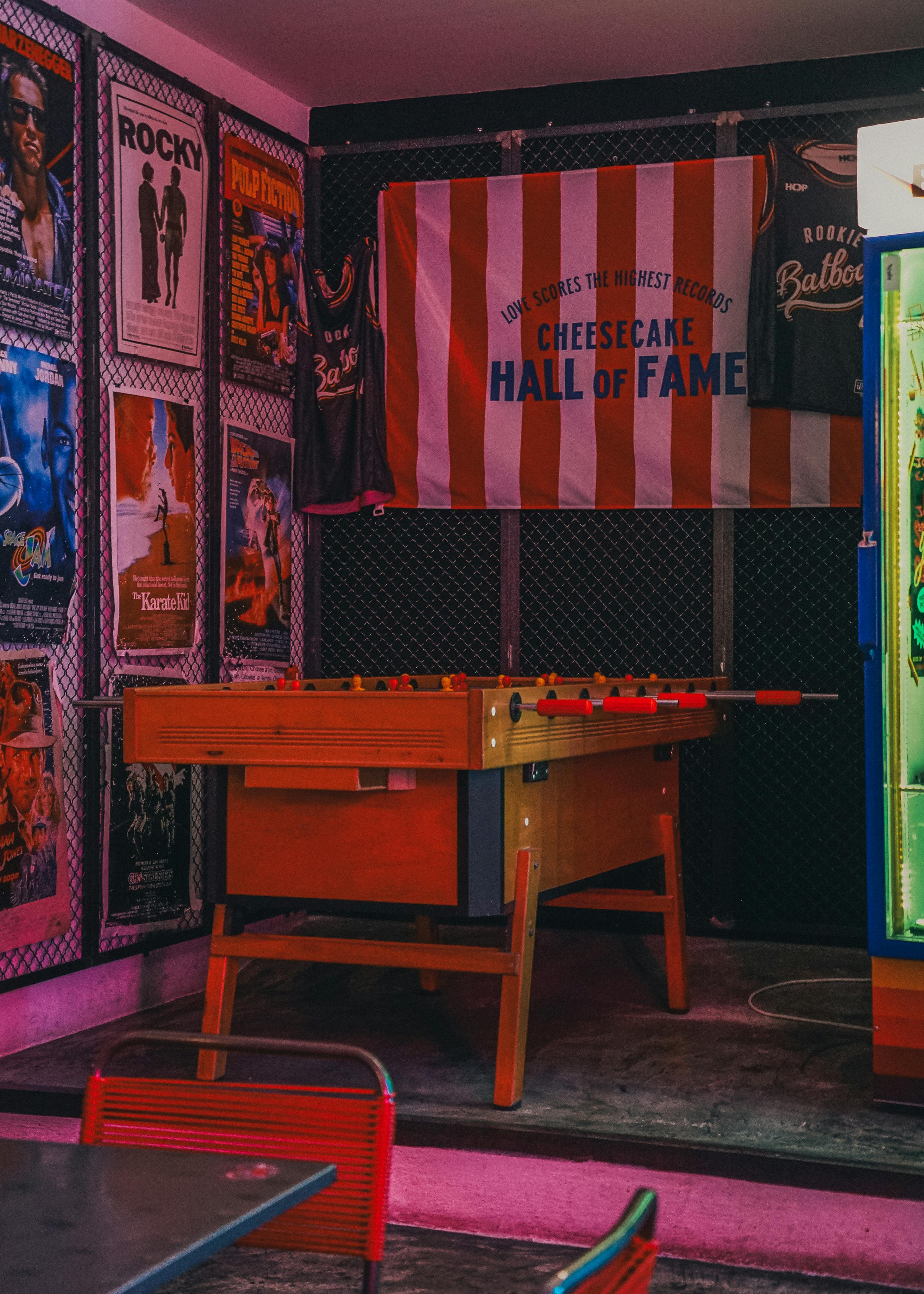 Retro Game Room with Foosball Table and Posters · Free Stock Photo