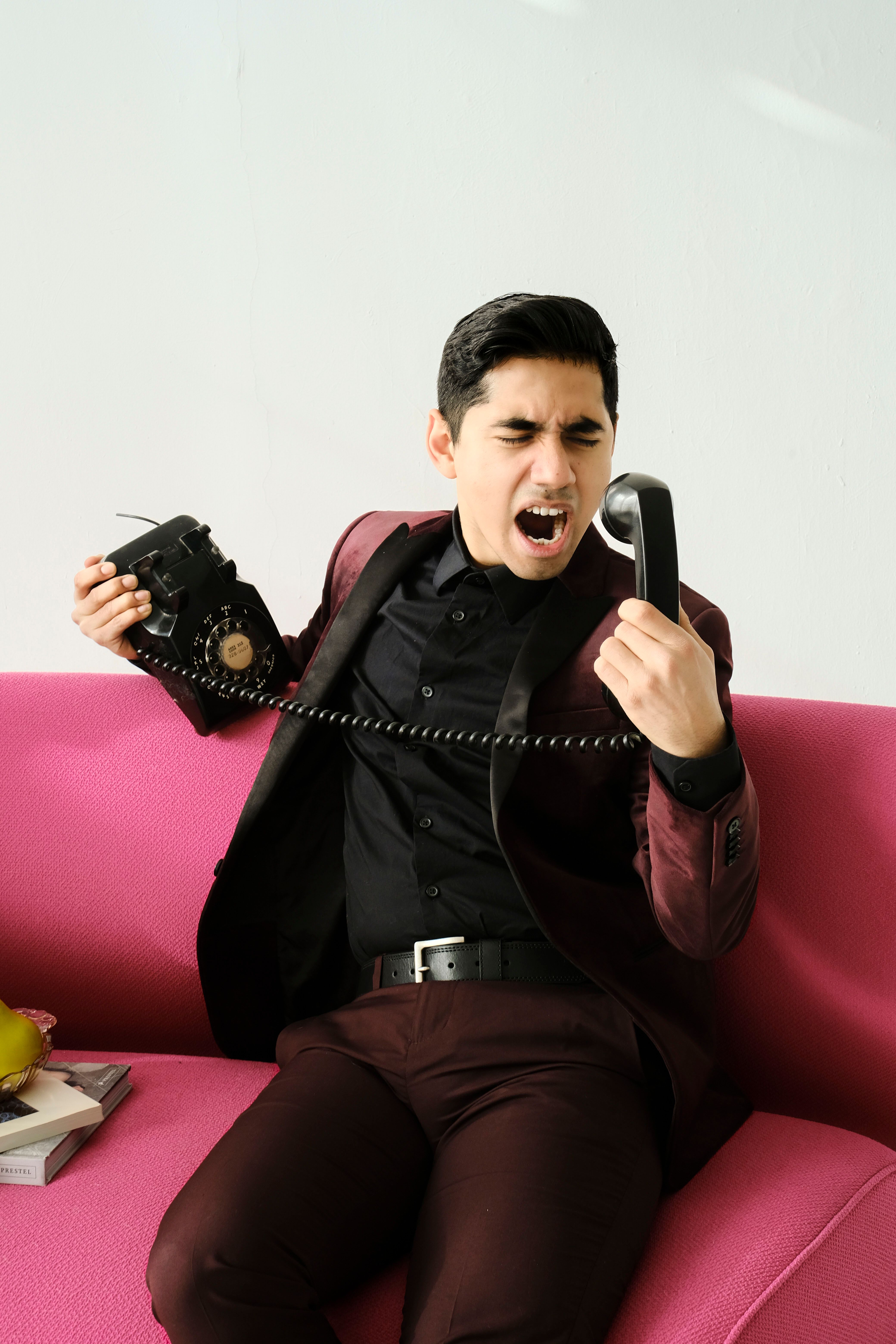 Man Expressing Frustration with Vintage Telephone · Free Stock Photo