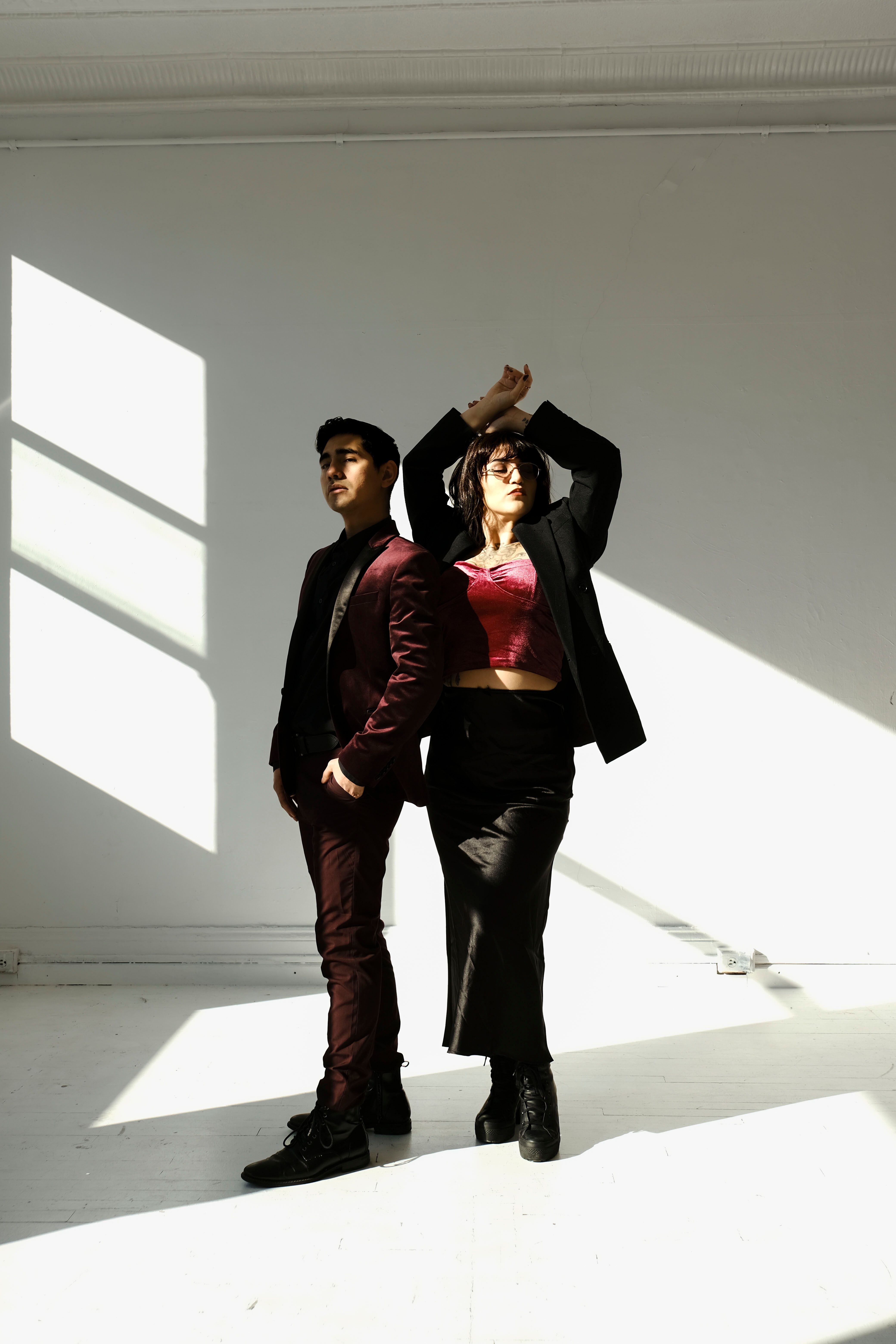 Fashionable Duo Posing in Sunlit Studio · Free Stock Photo