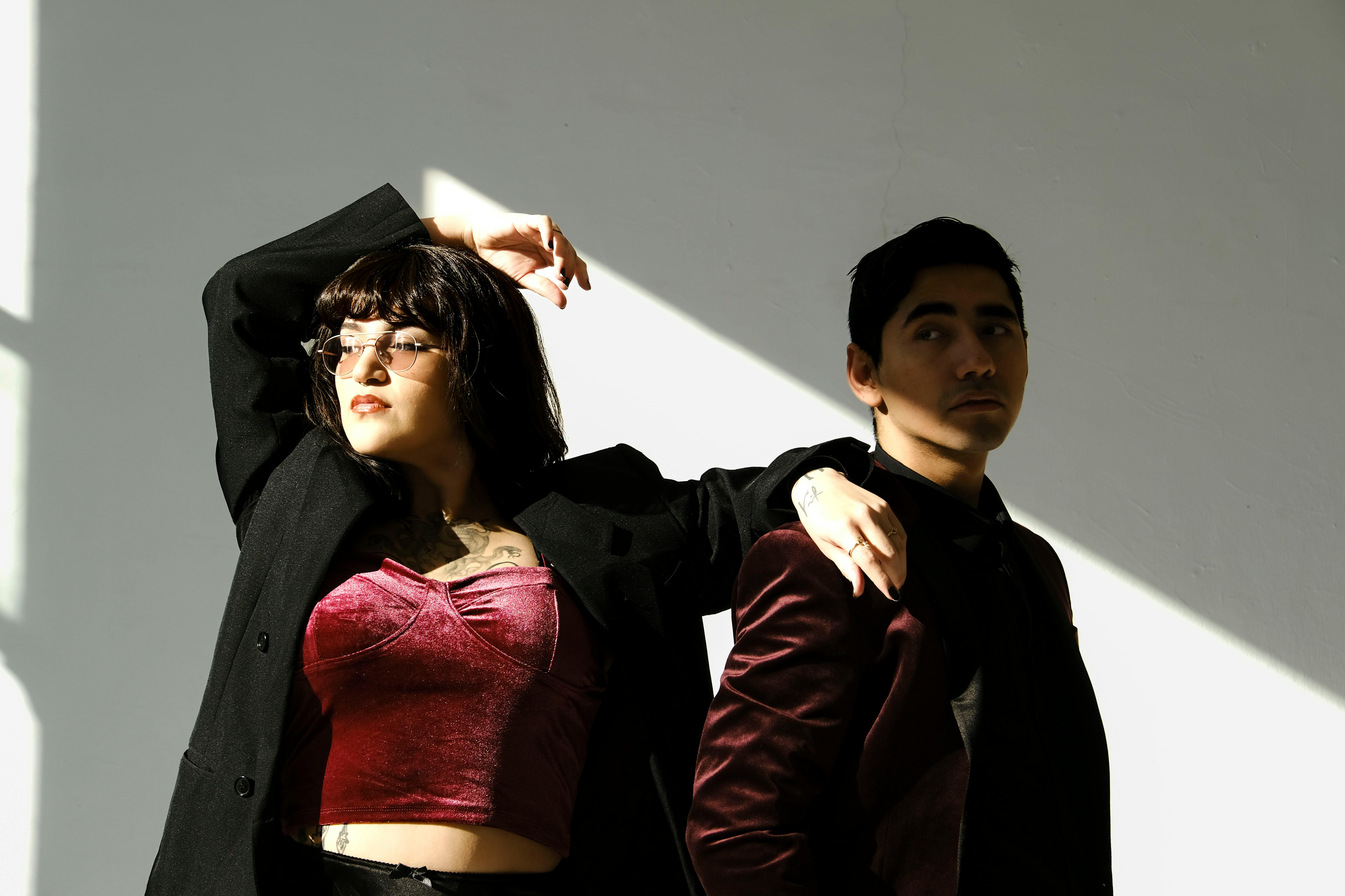 Stylish Couple in Dramatic Lighting Pose · Free Stock Photo