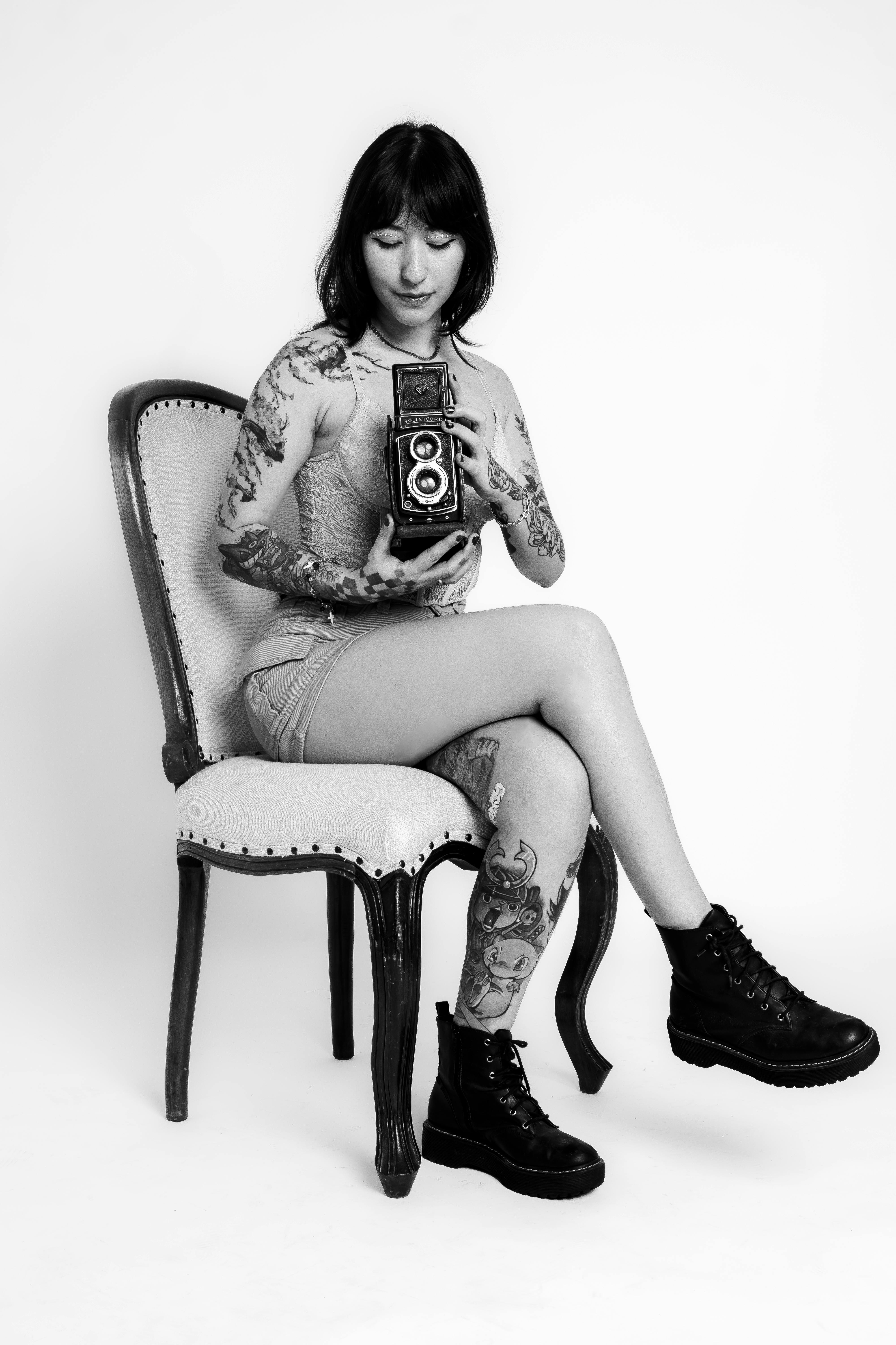 Tattooed Woman Poses with Vintage Camera · Free Stock Photo
