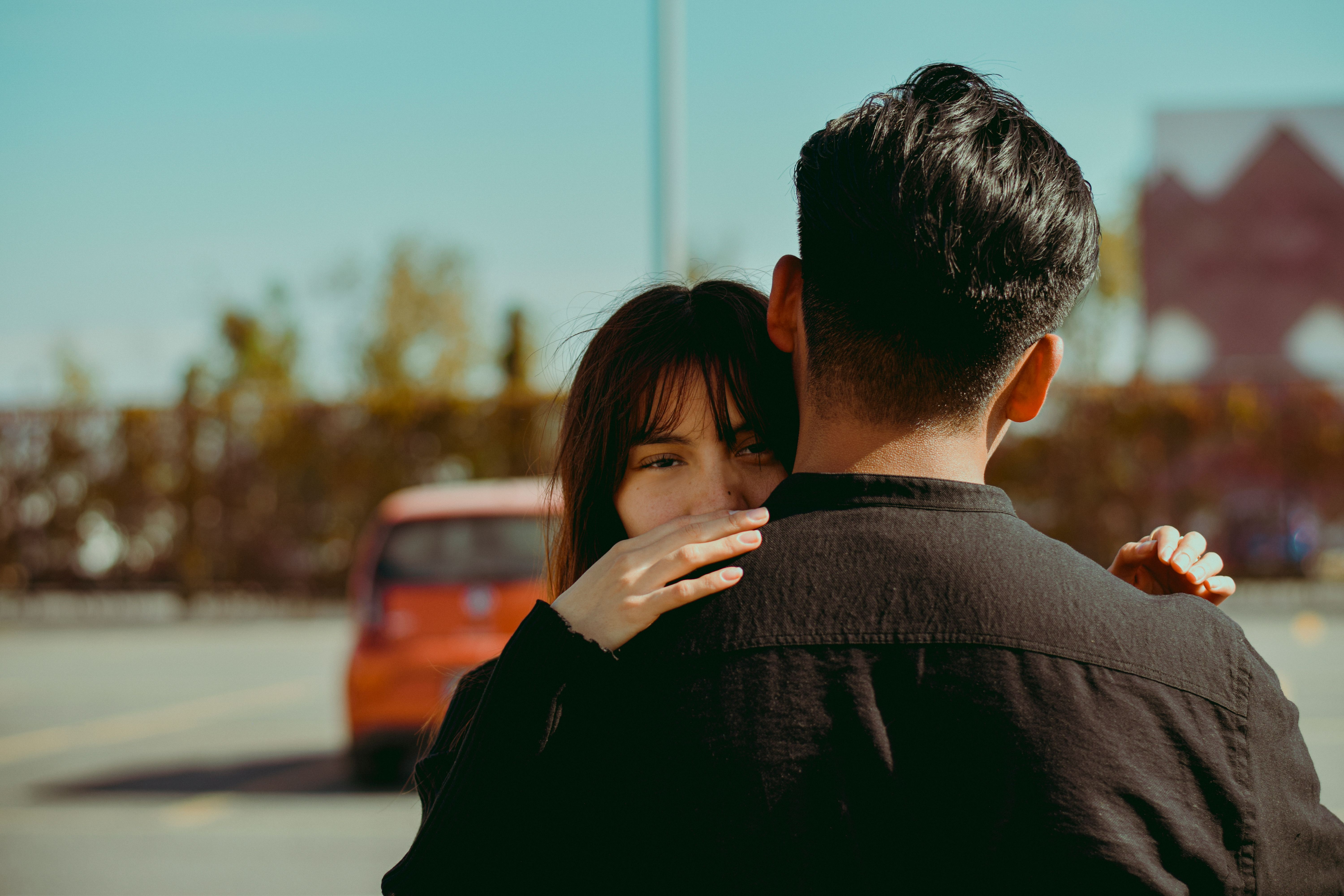 Tender Embrace in Urban Parking Lot · Free Stock Photo