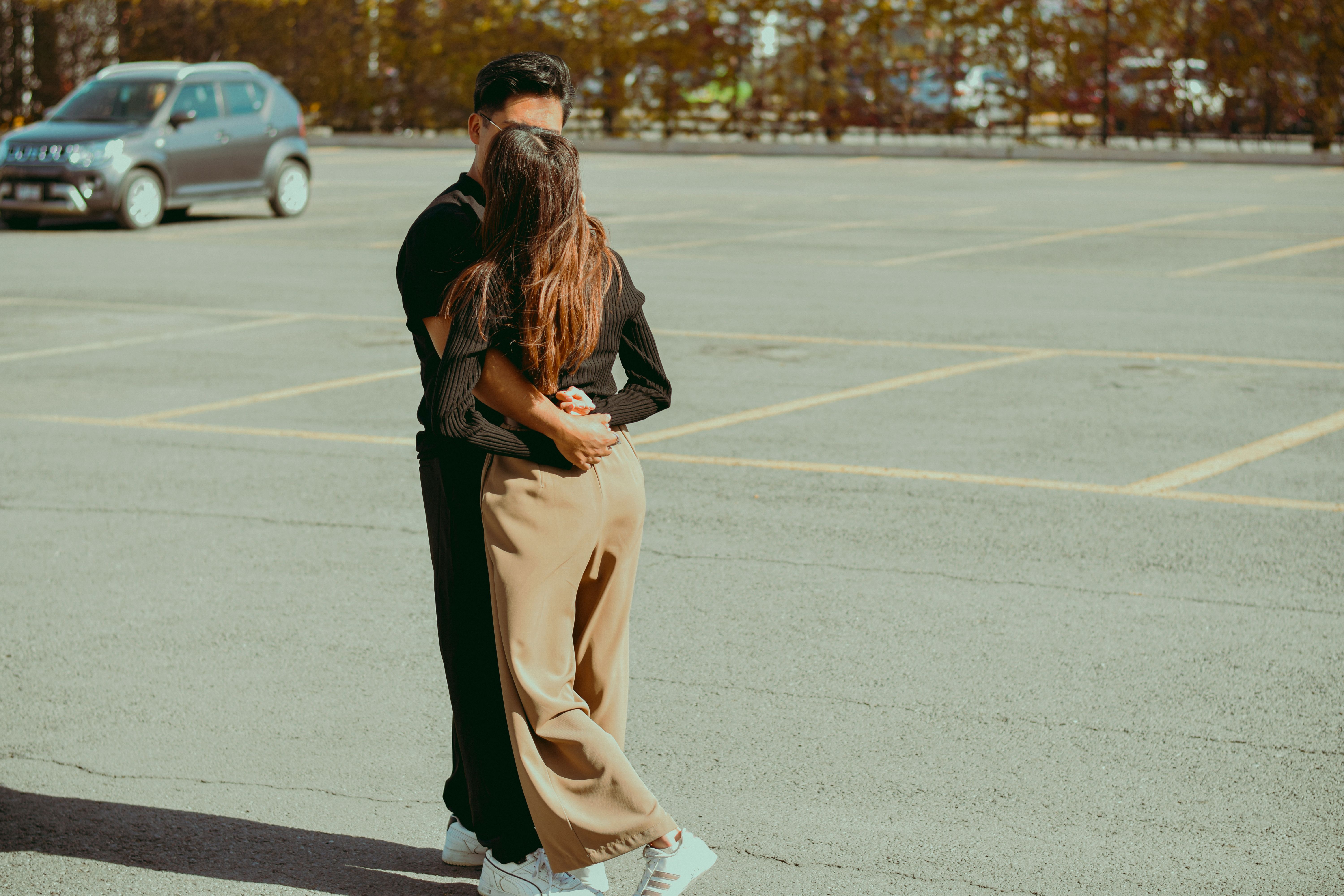 Couple Embracing in Empty Parking Lot · Free Stock Photo