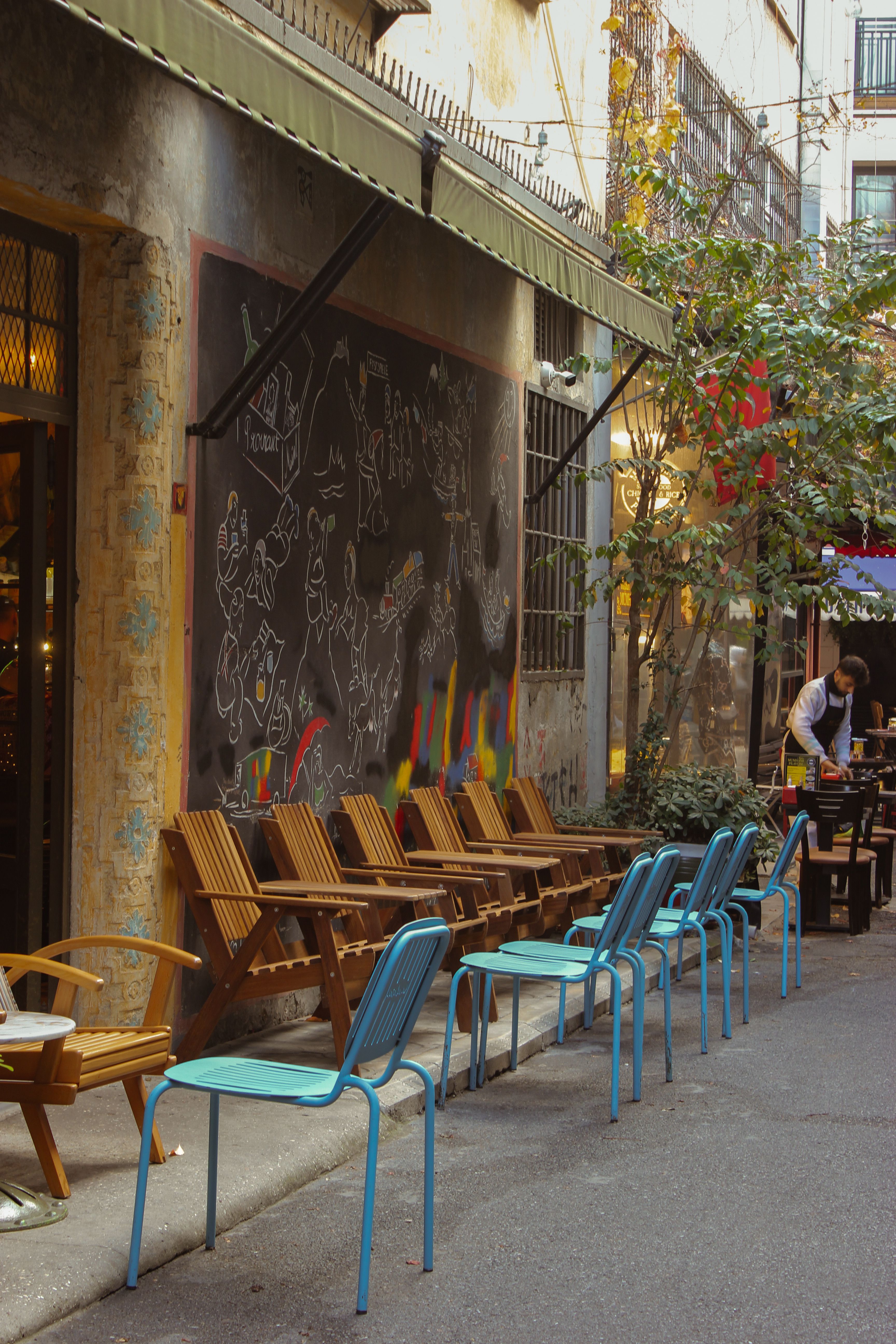 Charming Outdoor Cafe Seating on Quiet European Street · Free Stock Photo