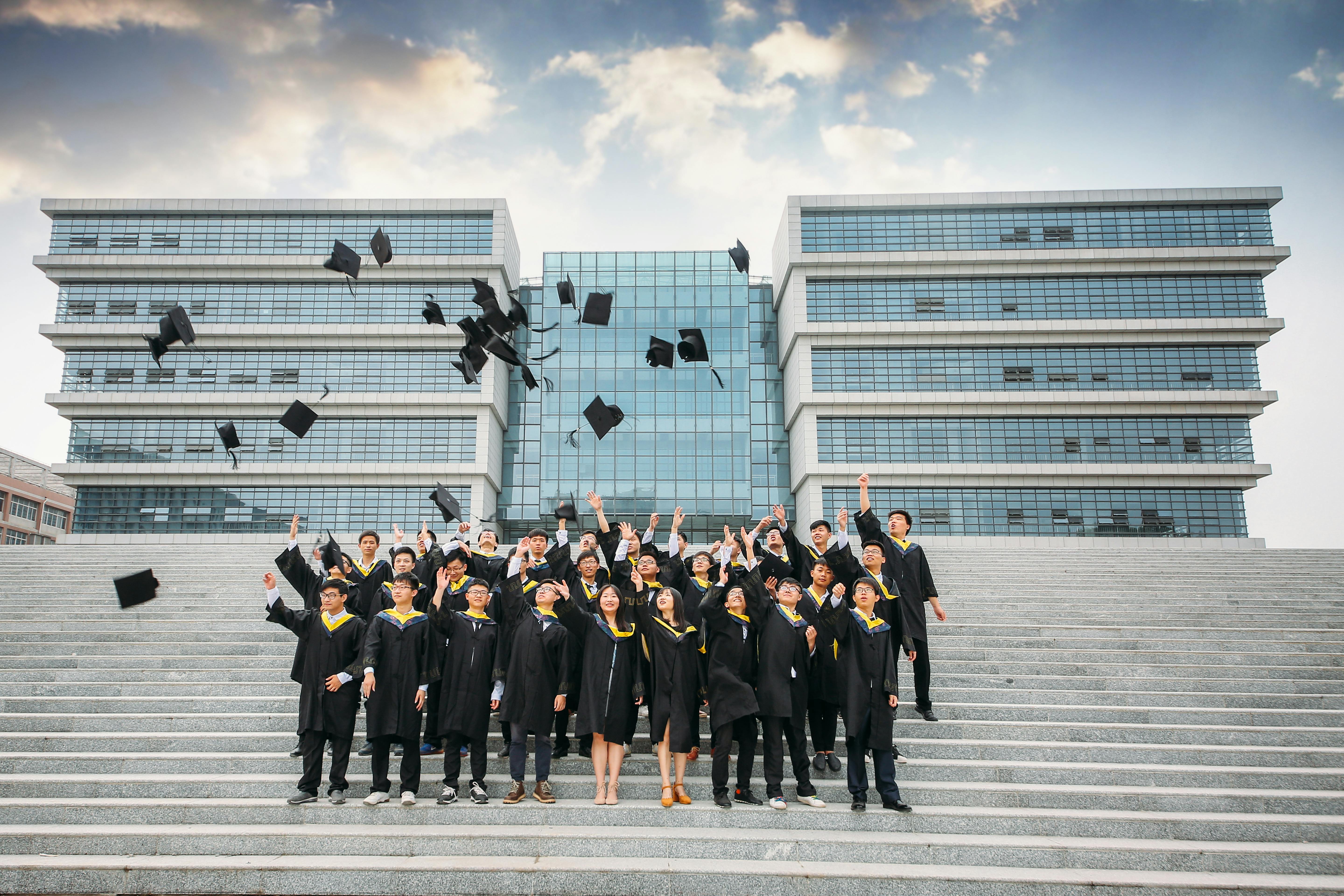 A Group of Person Holding Graduation Cap · Free Stock Photo