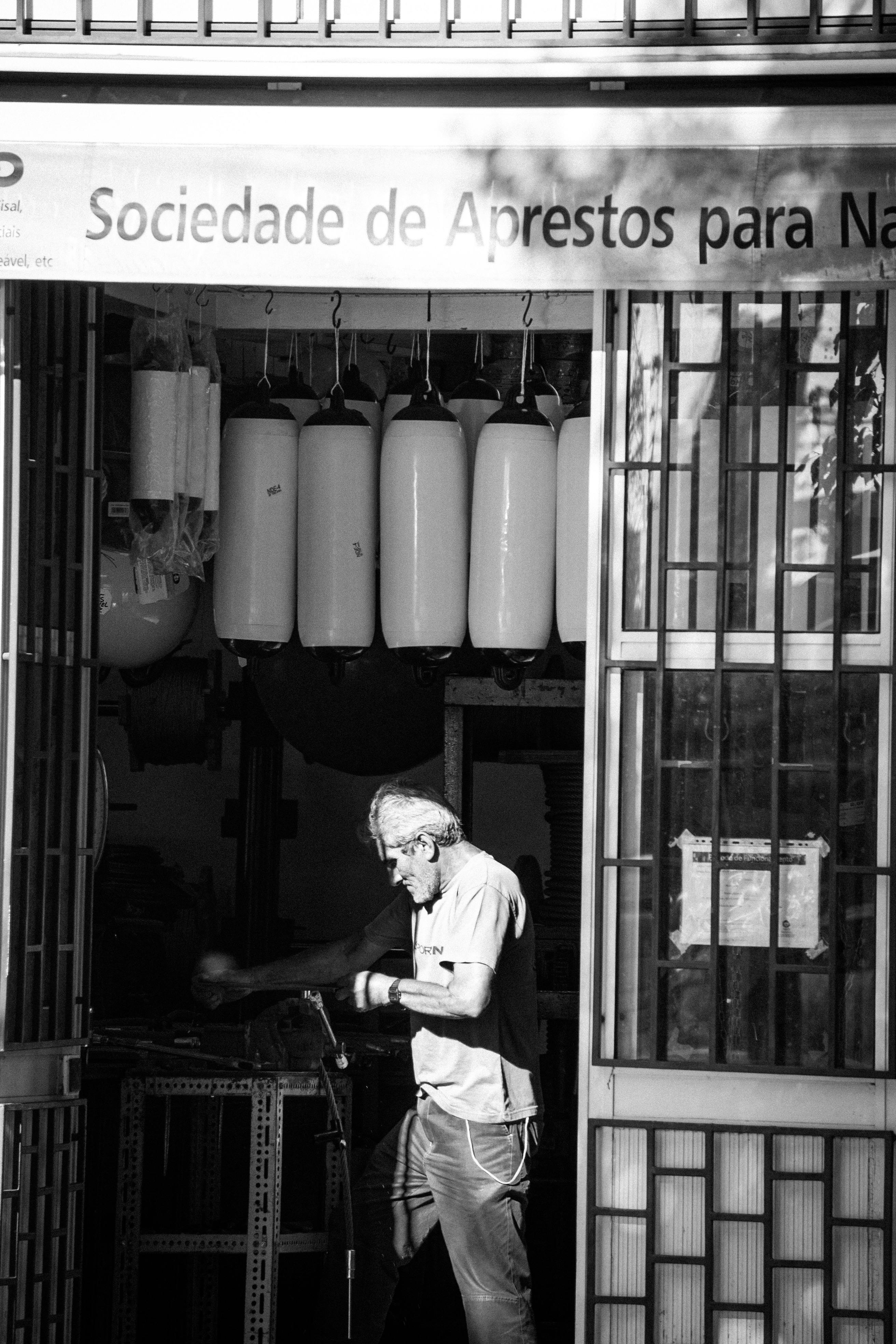 Black and White Workshop Entrance with Worker · Free Stock Photo