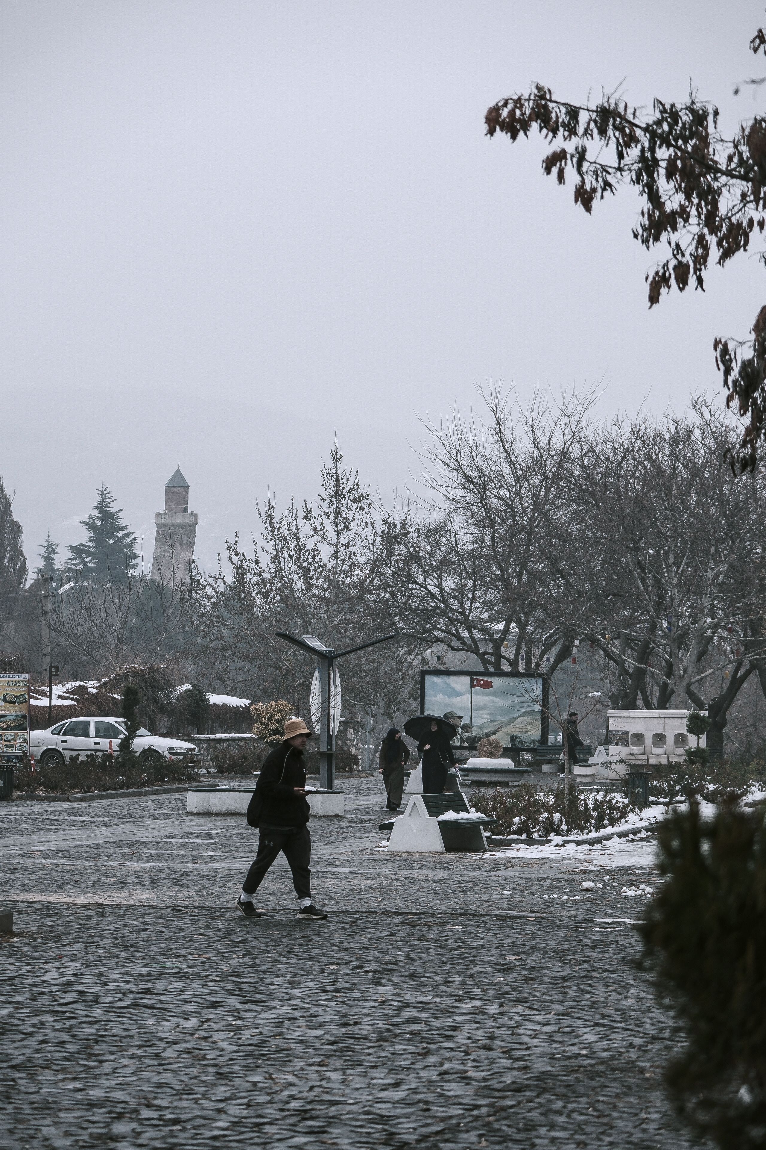 Winter Scene with People in Snowy Urban Park · Free Stock Photo