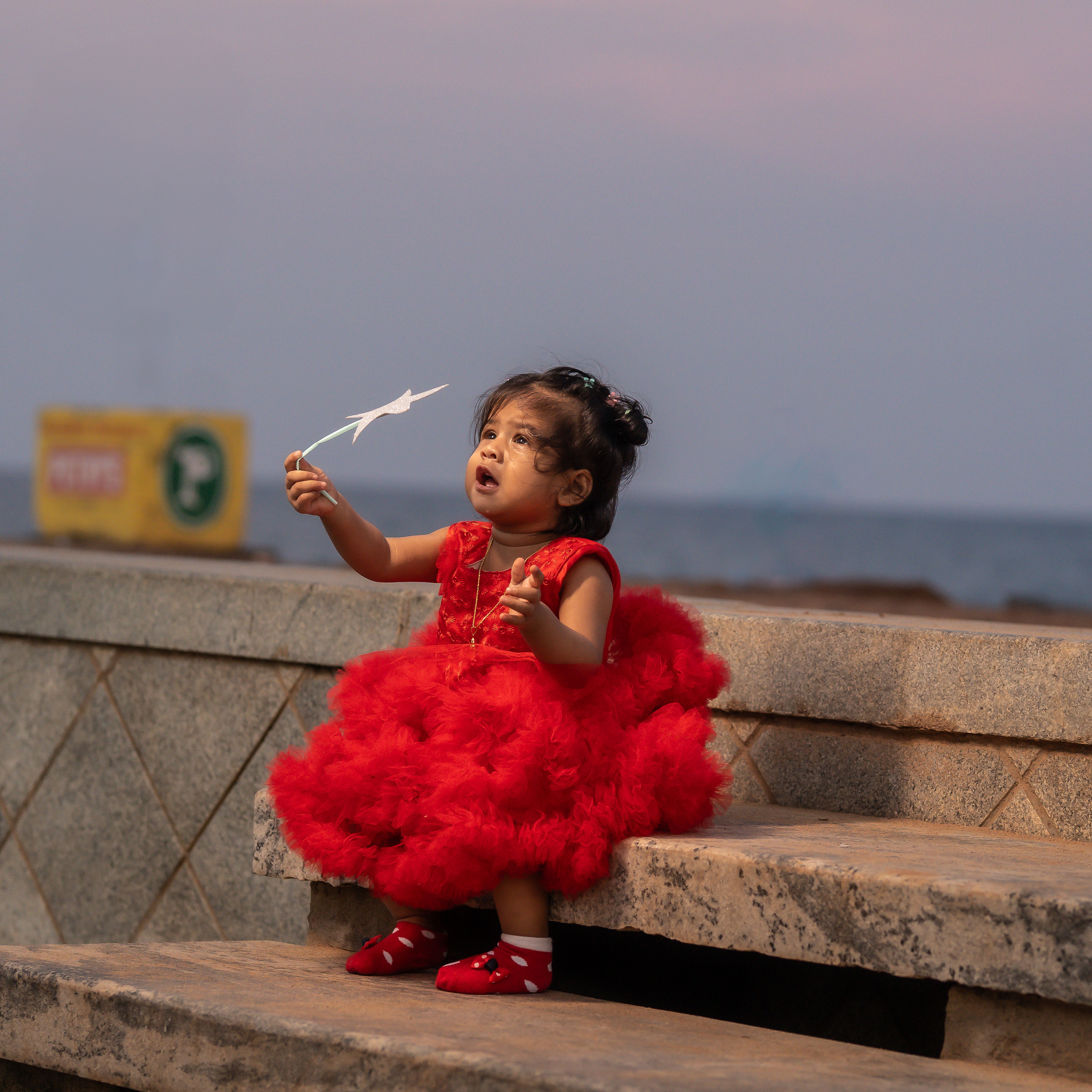 Adorable Child in Red Dress by Seaside at Twilight · Free Stock Photo