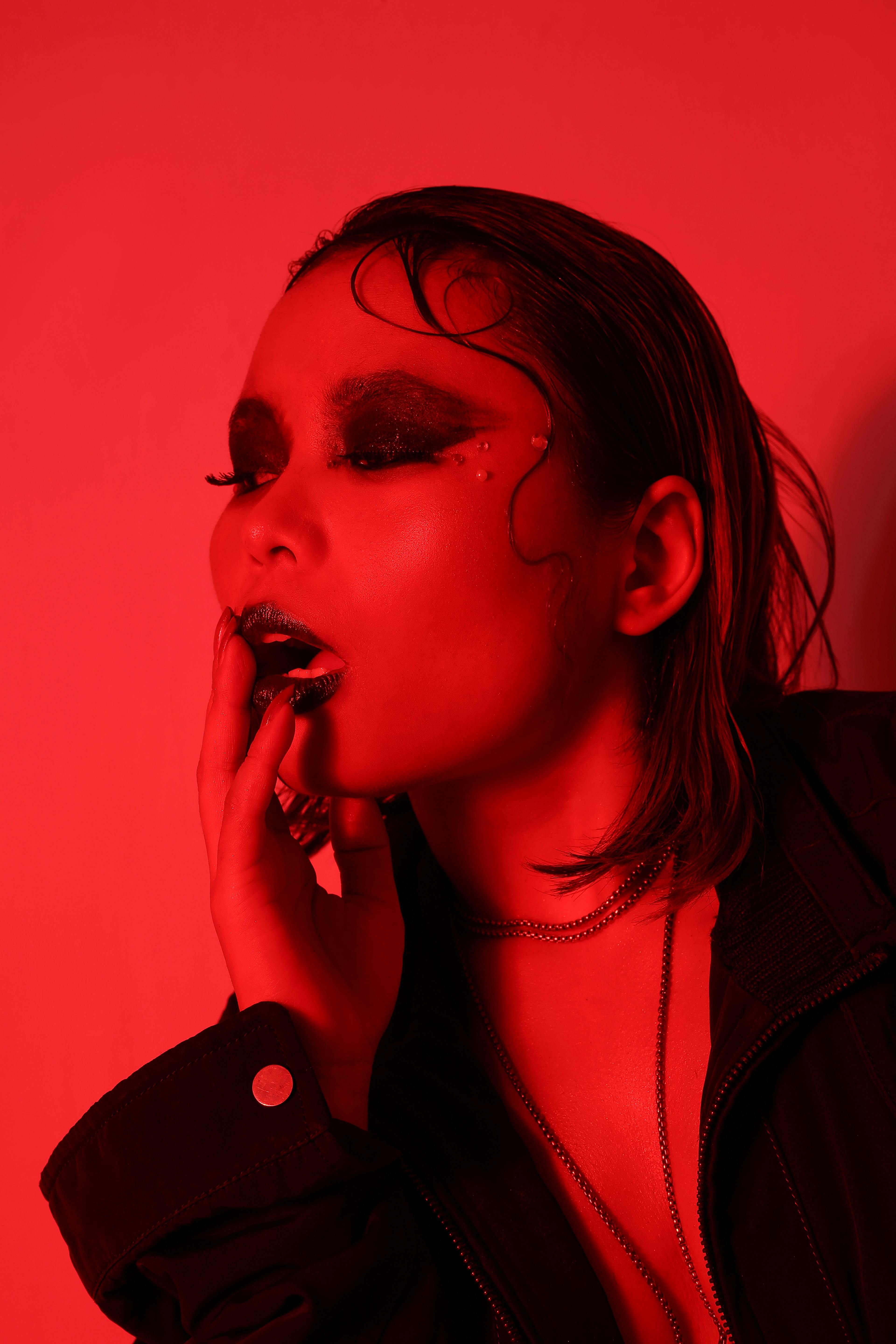Creative Makeup Portrait in Dramatic Red Lighting · Free Stock Photo