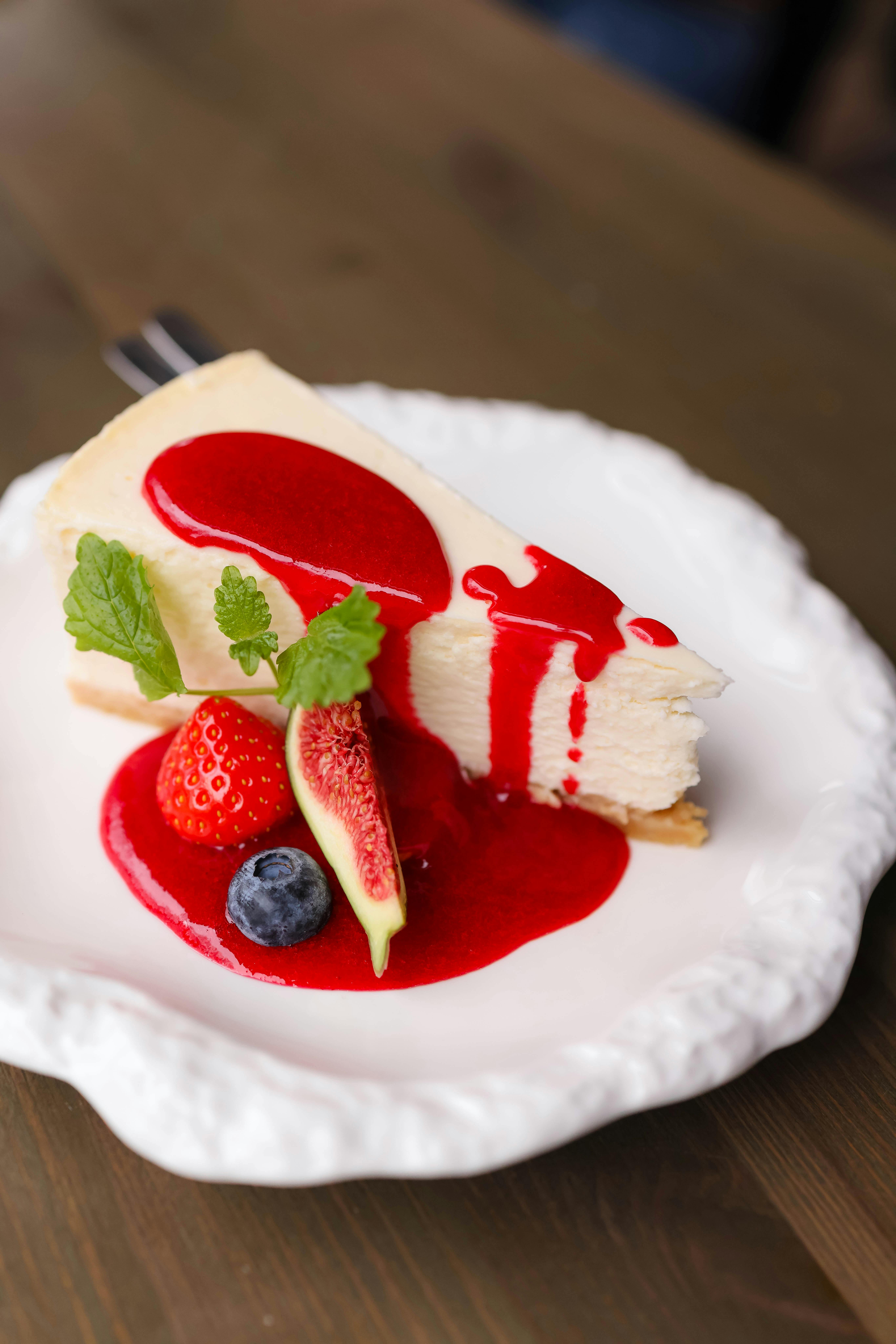 Delicious Cheesecake with Berry Topping on White Plate · Free Stock Photo