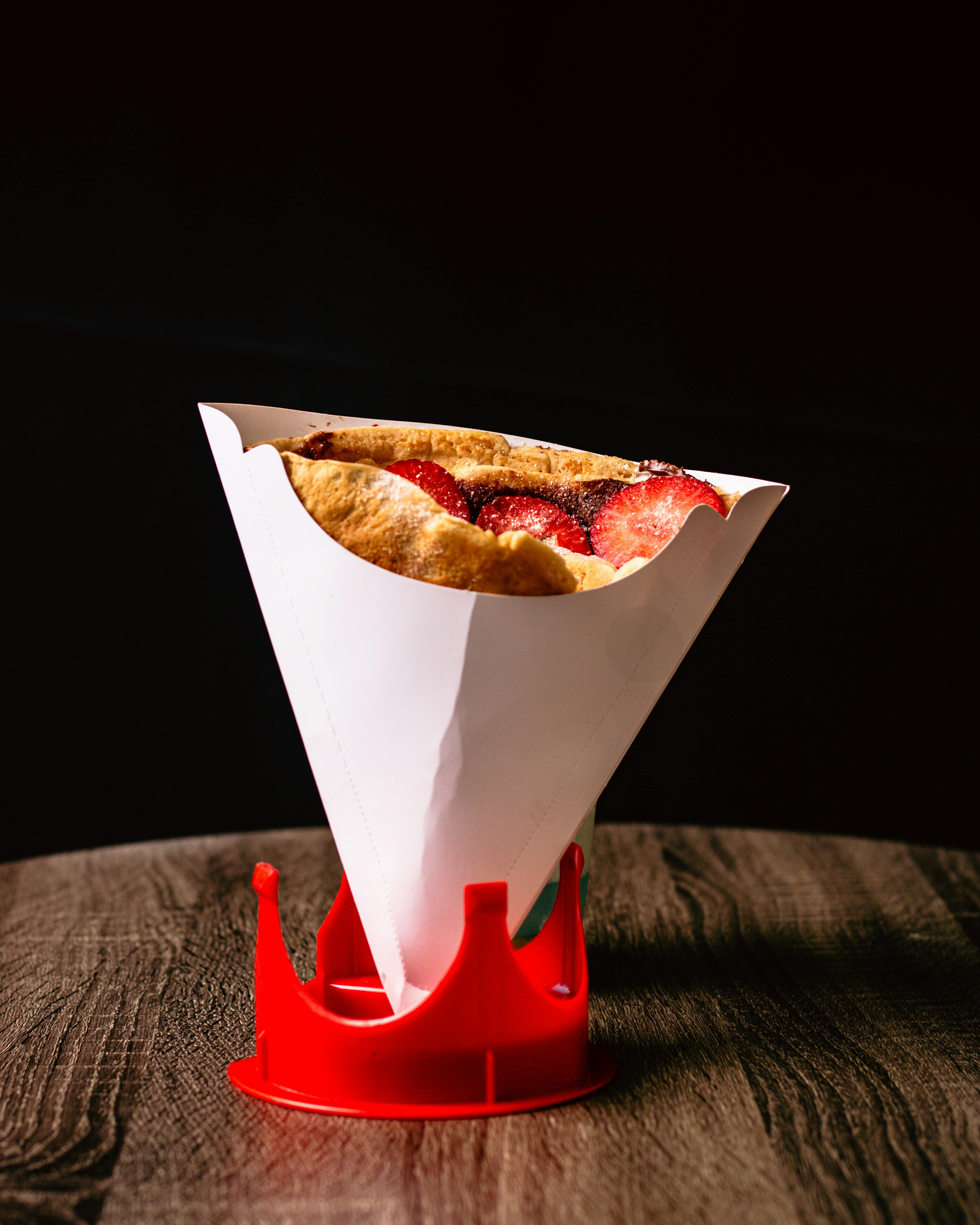 Delicious Strawberry Crepe in Paper Cone with Dark Background · Free ...