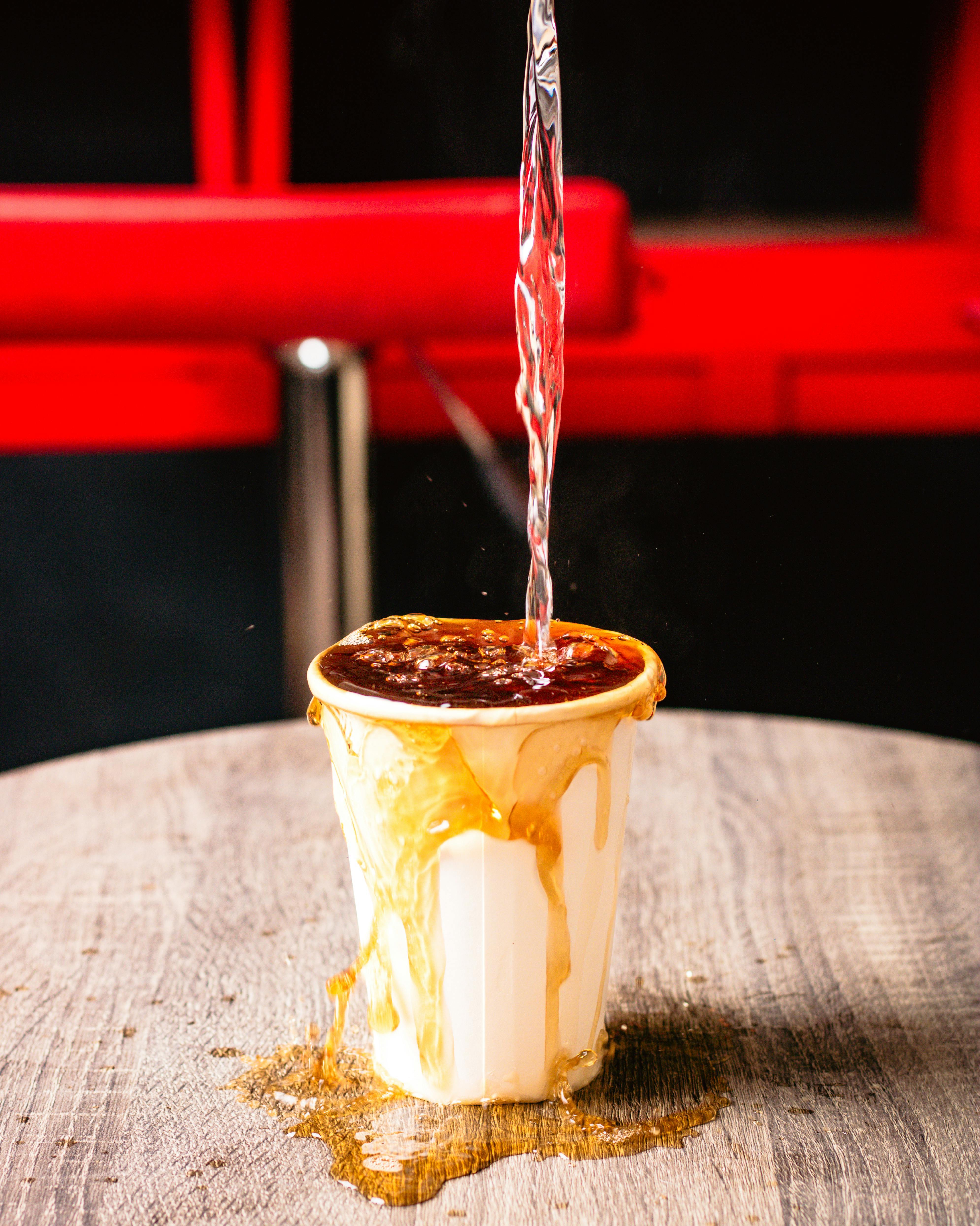 Overflowing Beverage Cup with Pouring Liquid · Free Stock Photo