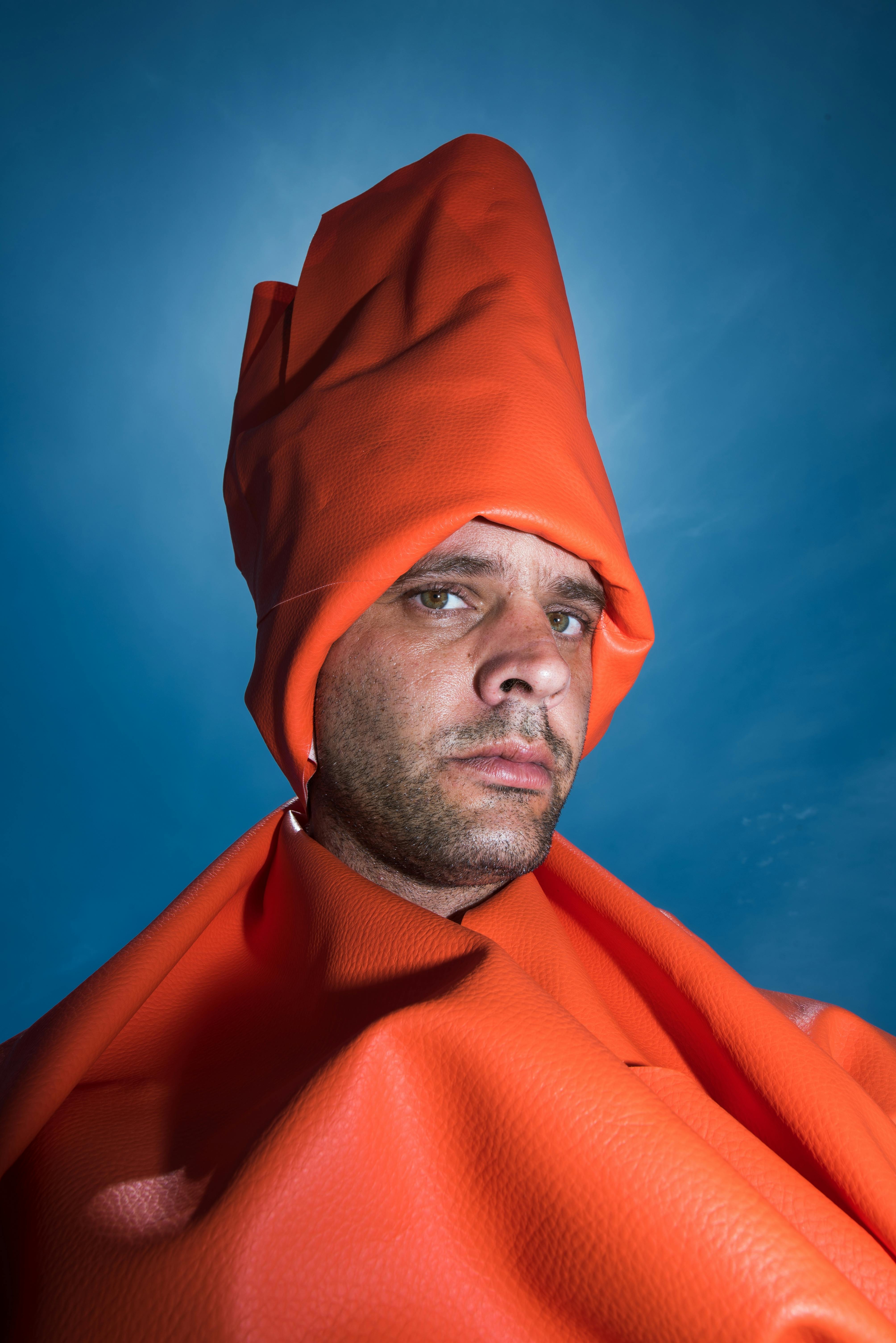 Portrait of Man in Bright Orange Costume · Free Stock Photo
