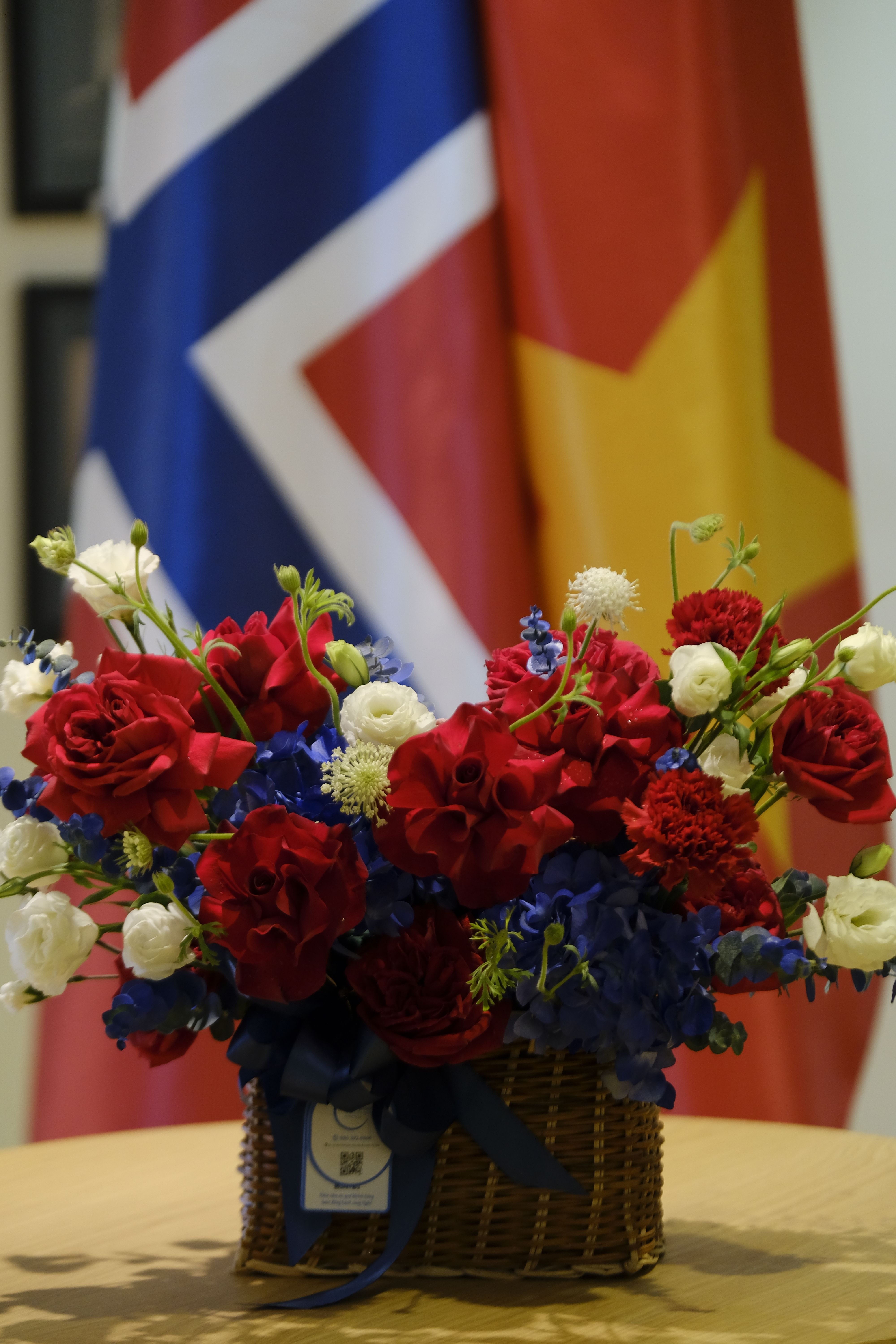 Vibrant Flower Arrangement with Flags in Background · Free Stock Photo