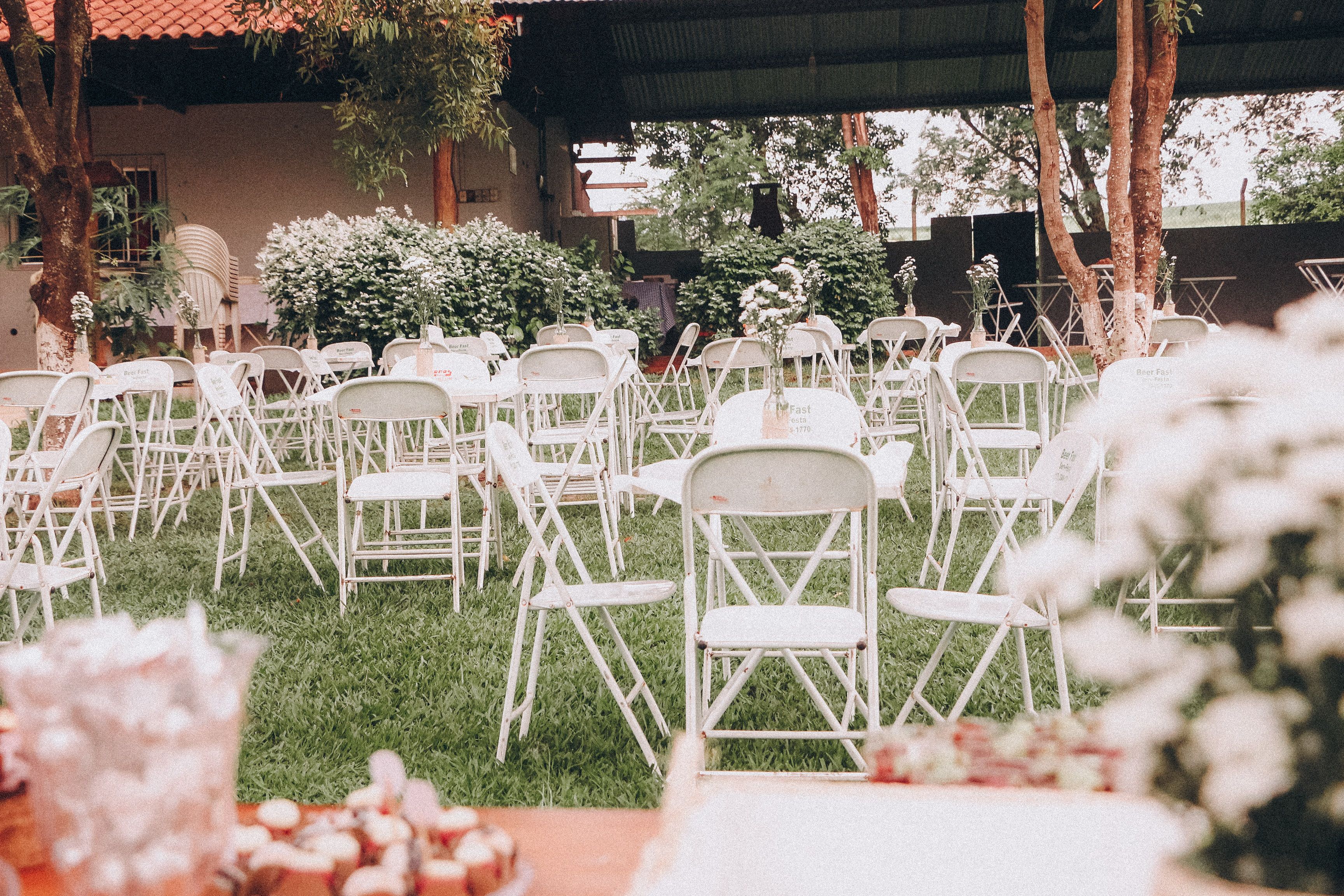 Outdoor Wedding Setup with White Chairs · Free Stock Photo