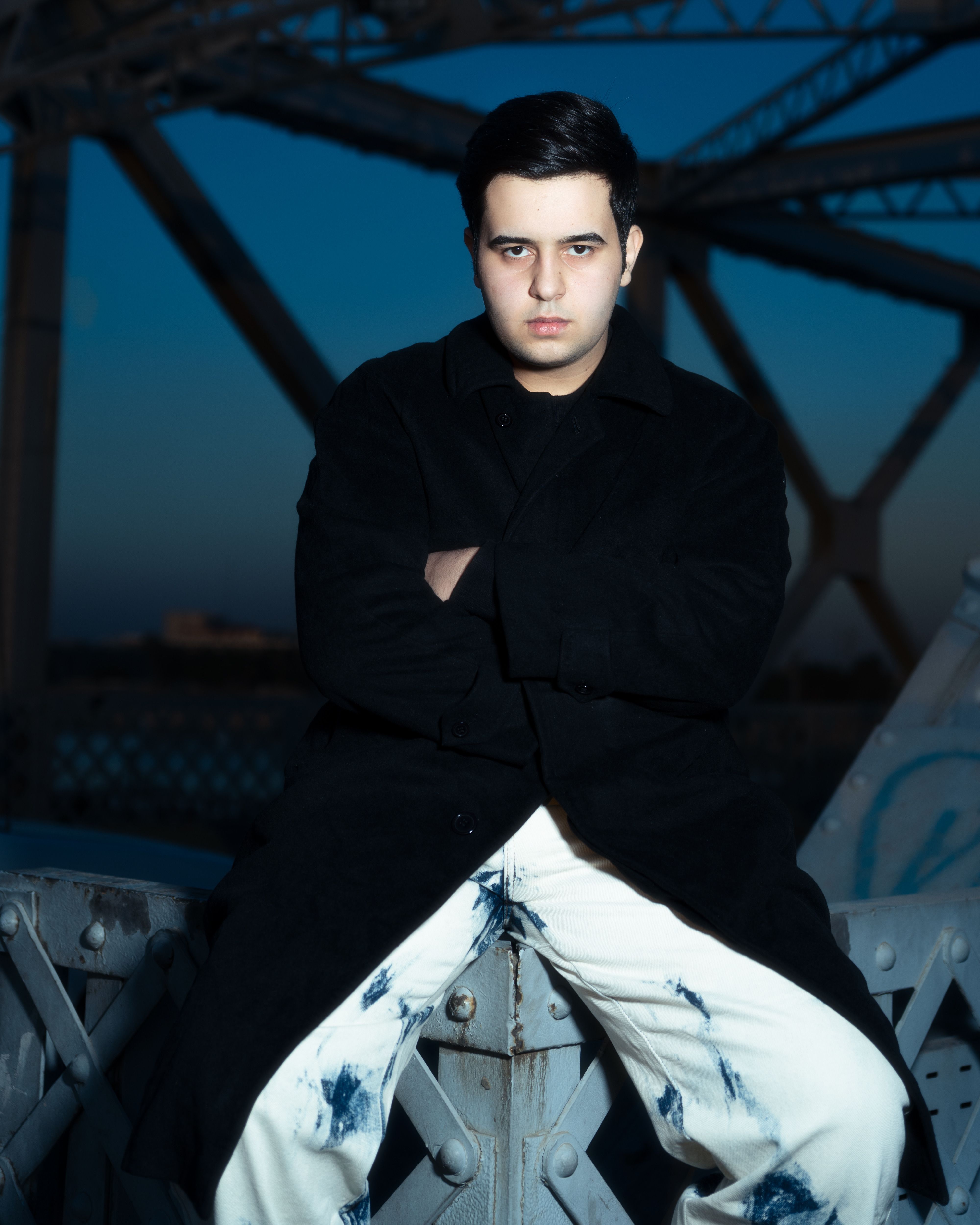 Moody Portrait of a Man on a Bridge at Twilight · Free Stock Photo