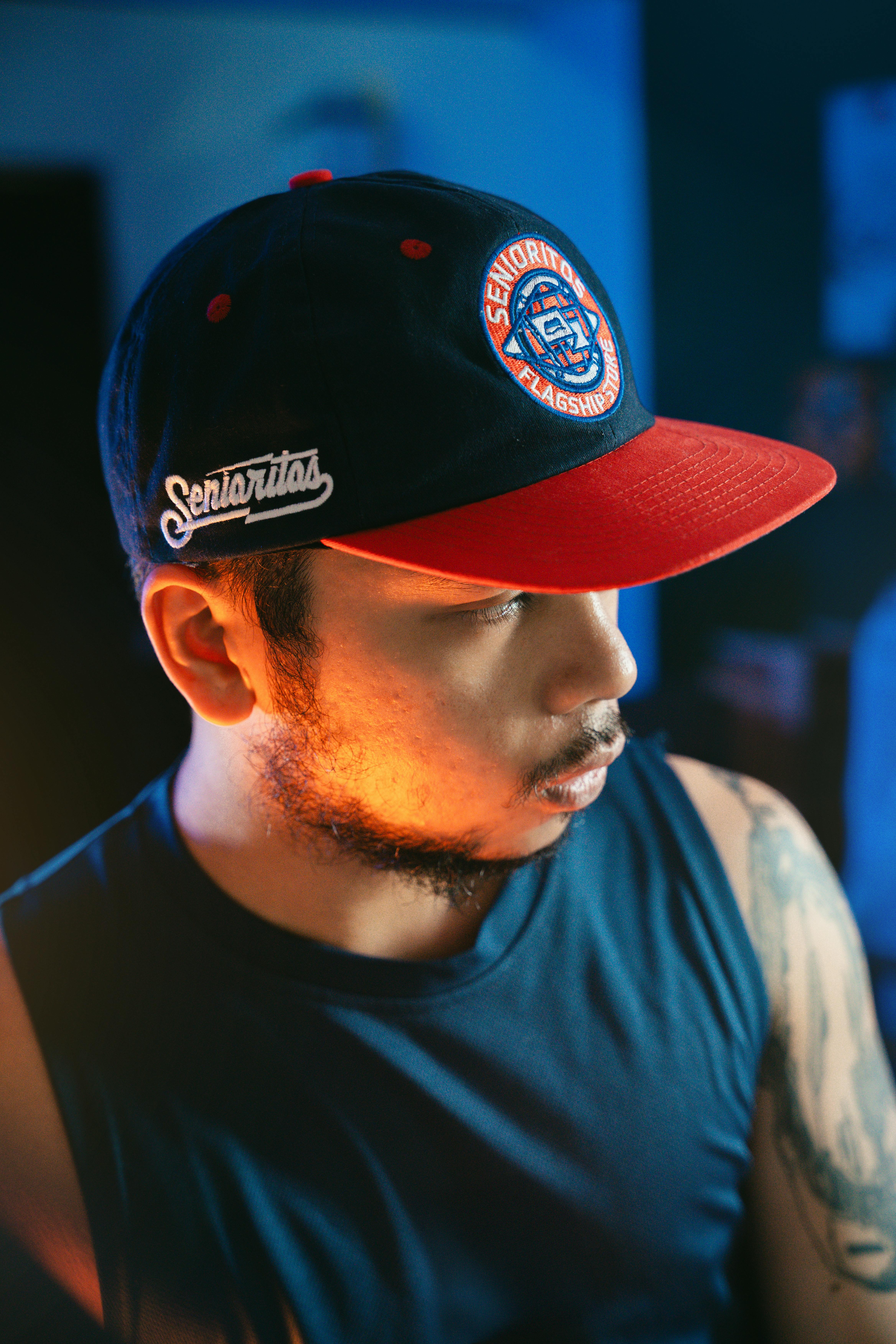 Portrait of a Man Wearing a Graphic Baseball Cap · Free Stock Photo